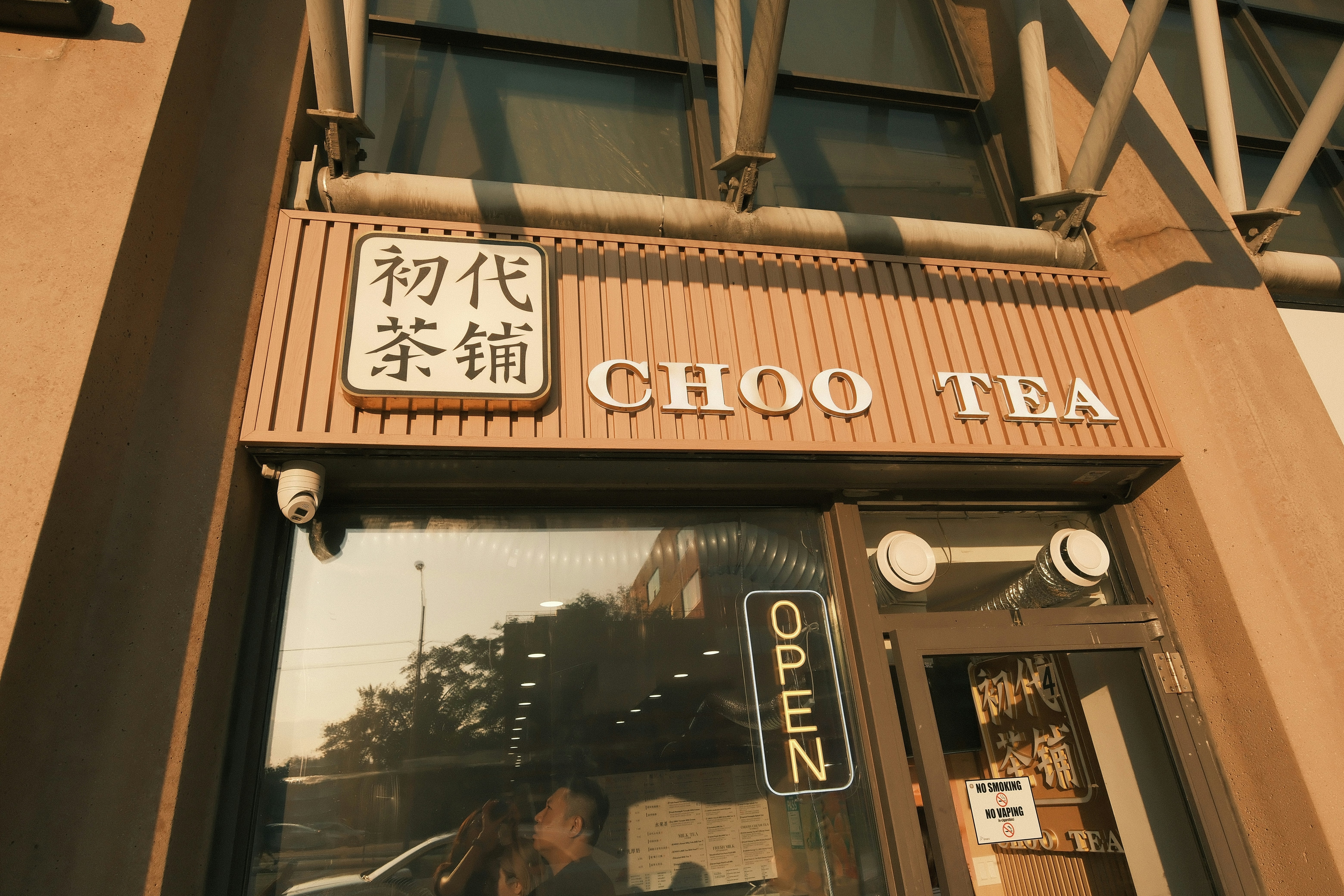 Choo Tea: Street-Side Entrance to a Warm-Orange Café