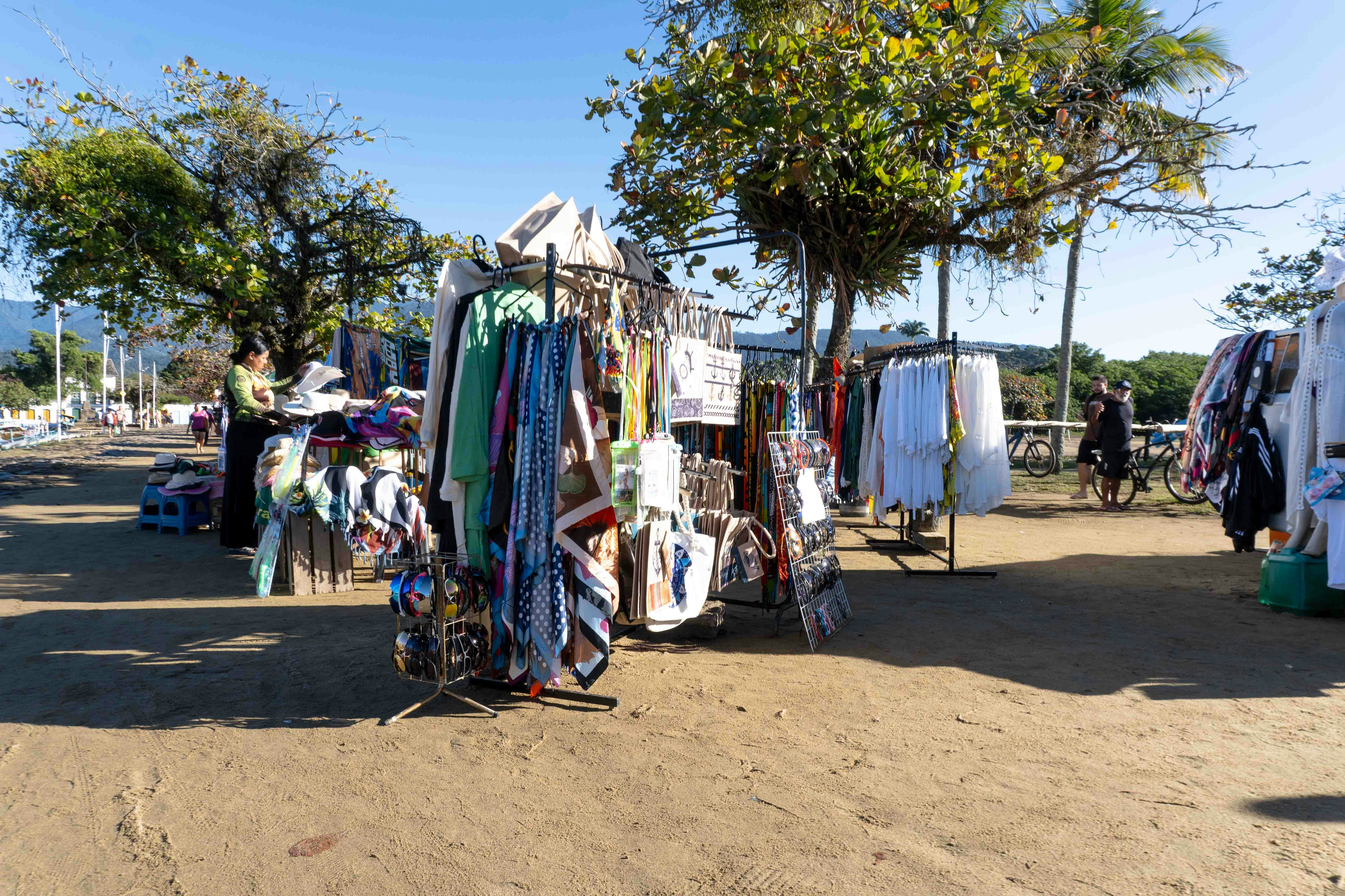 Sunlit Market Stalls on a Sandy Plaza