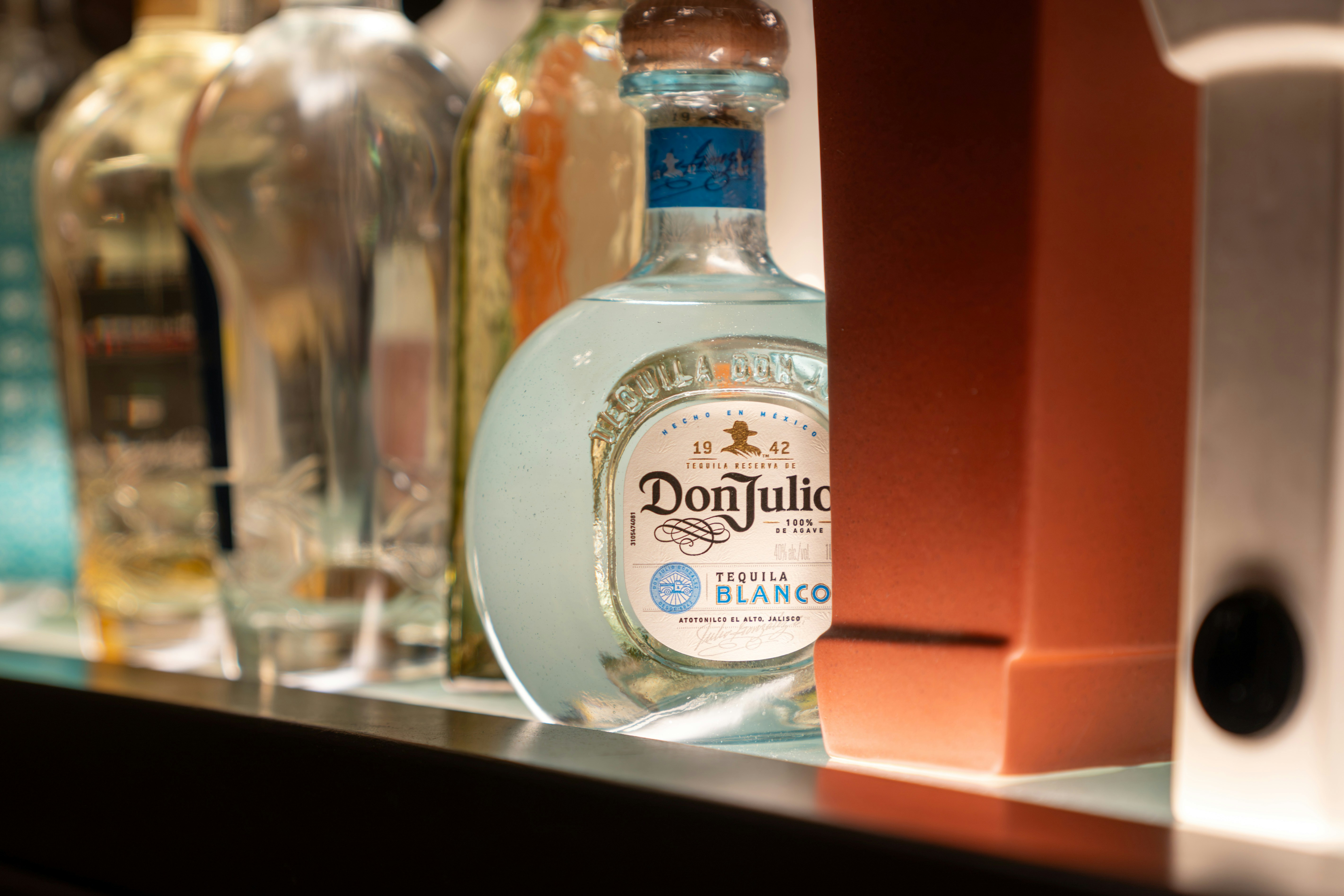 Blue Tequila Bottle on a Bar Shelf