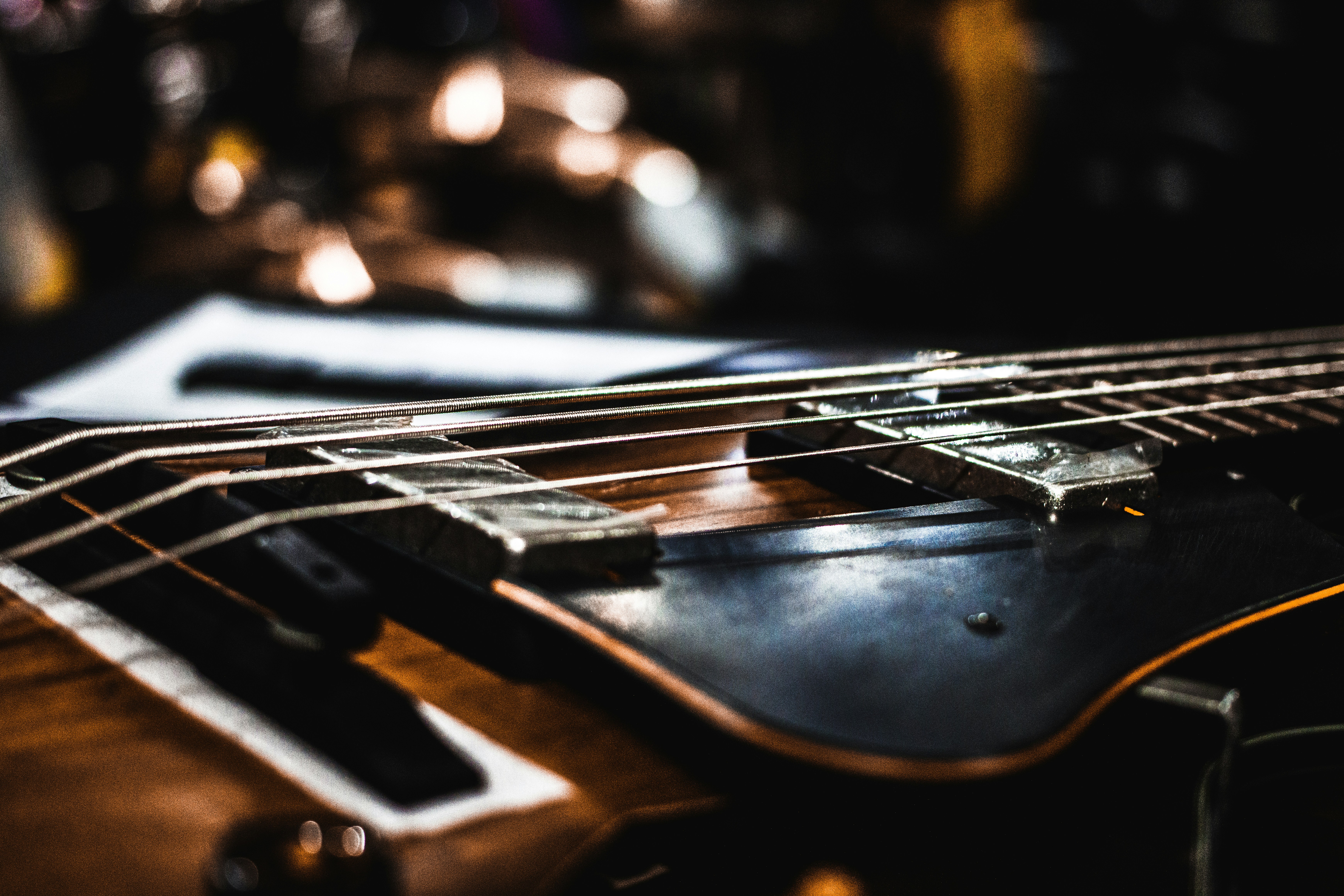Strings in Focus: A Close-Up of a Guitar's Bridge and Strings