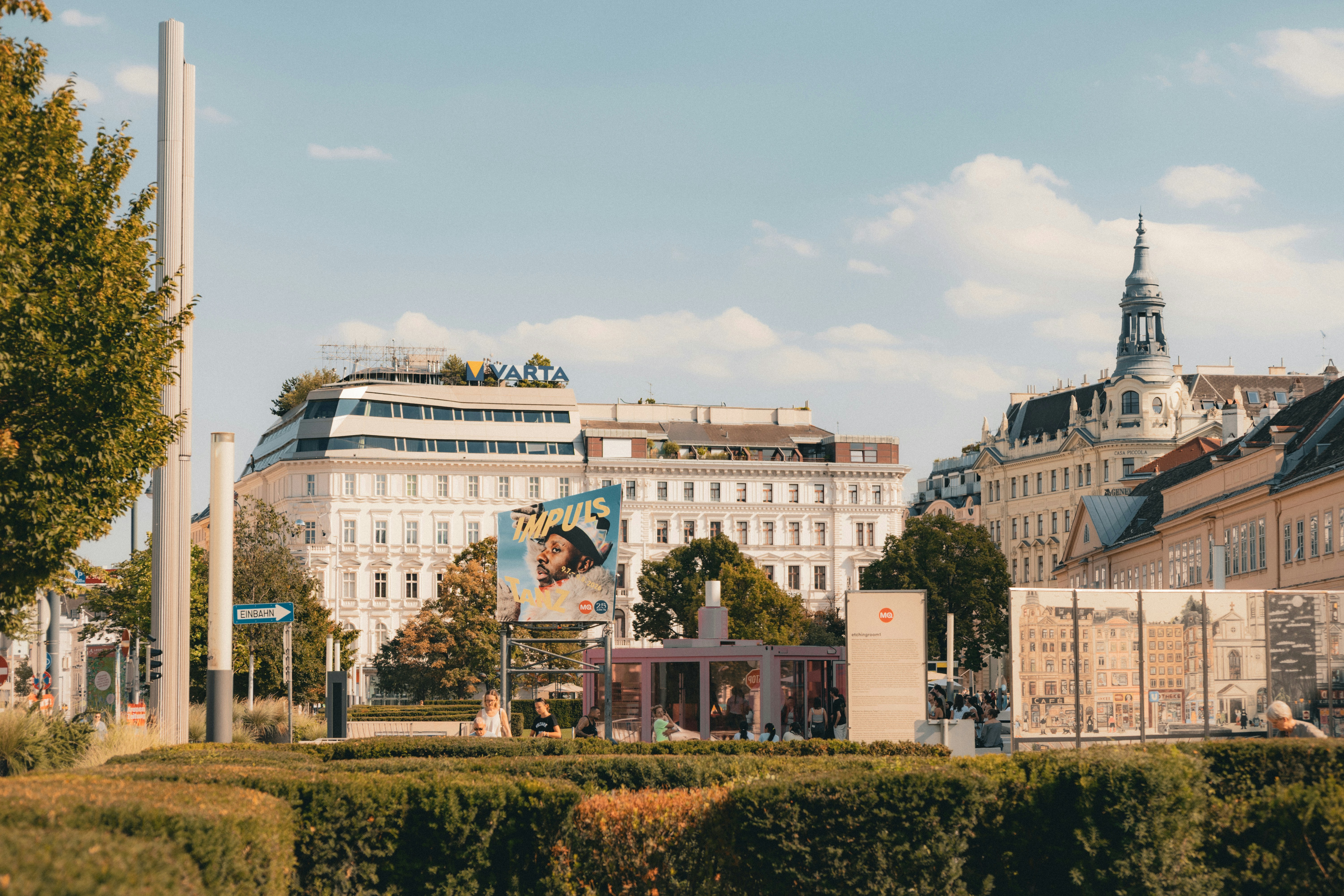 A Sunlit City Square framed by classic architecture