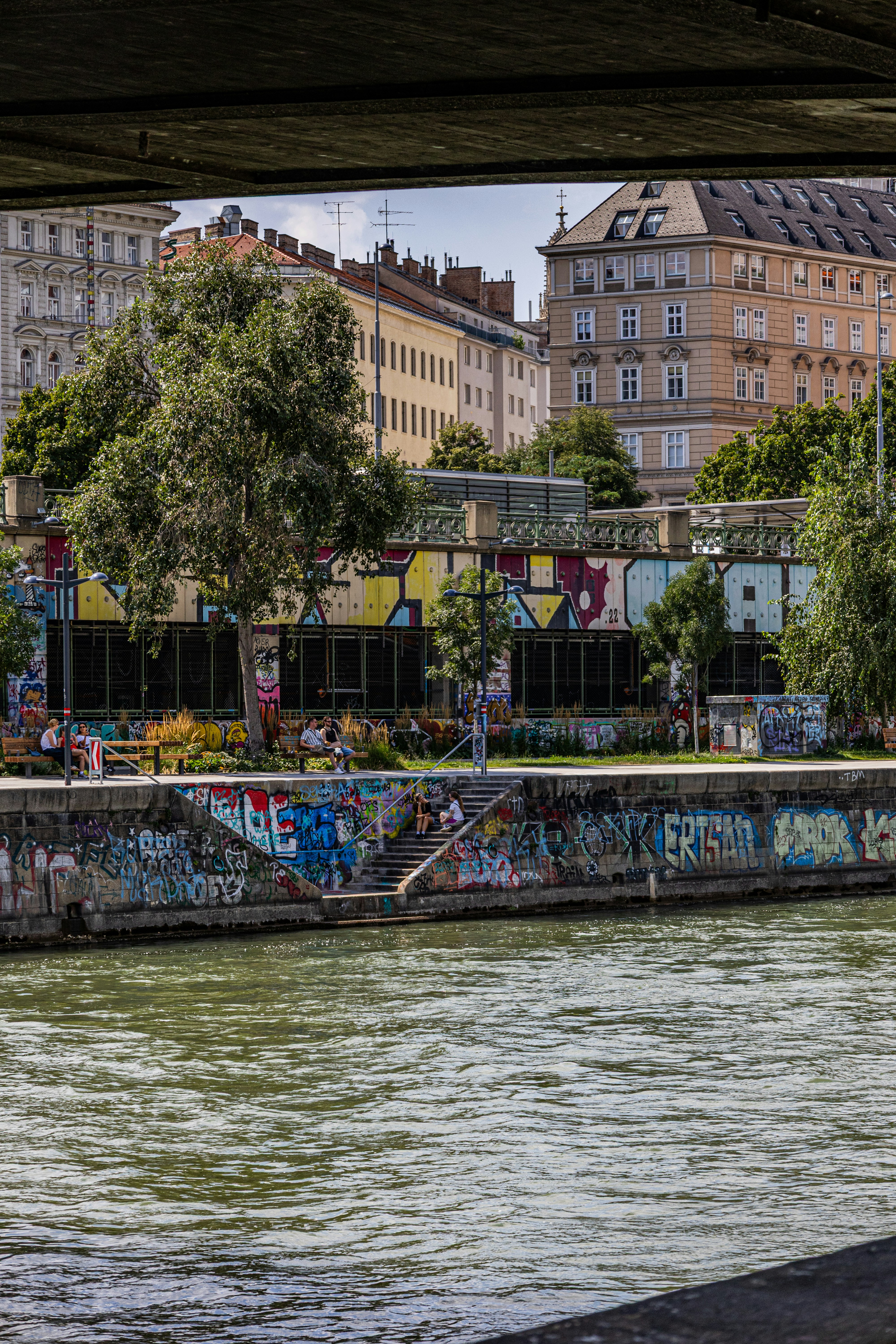 Graffiti by the Waterfront: Colorful Noon Along the River
