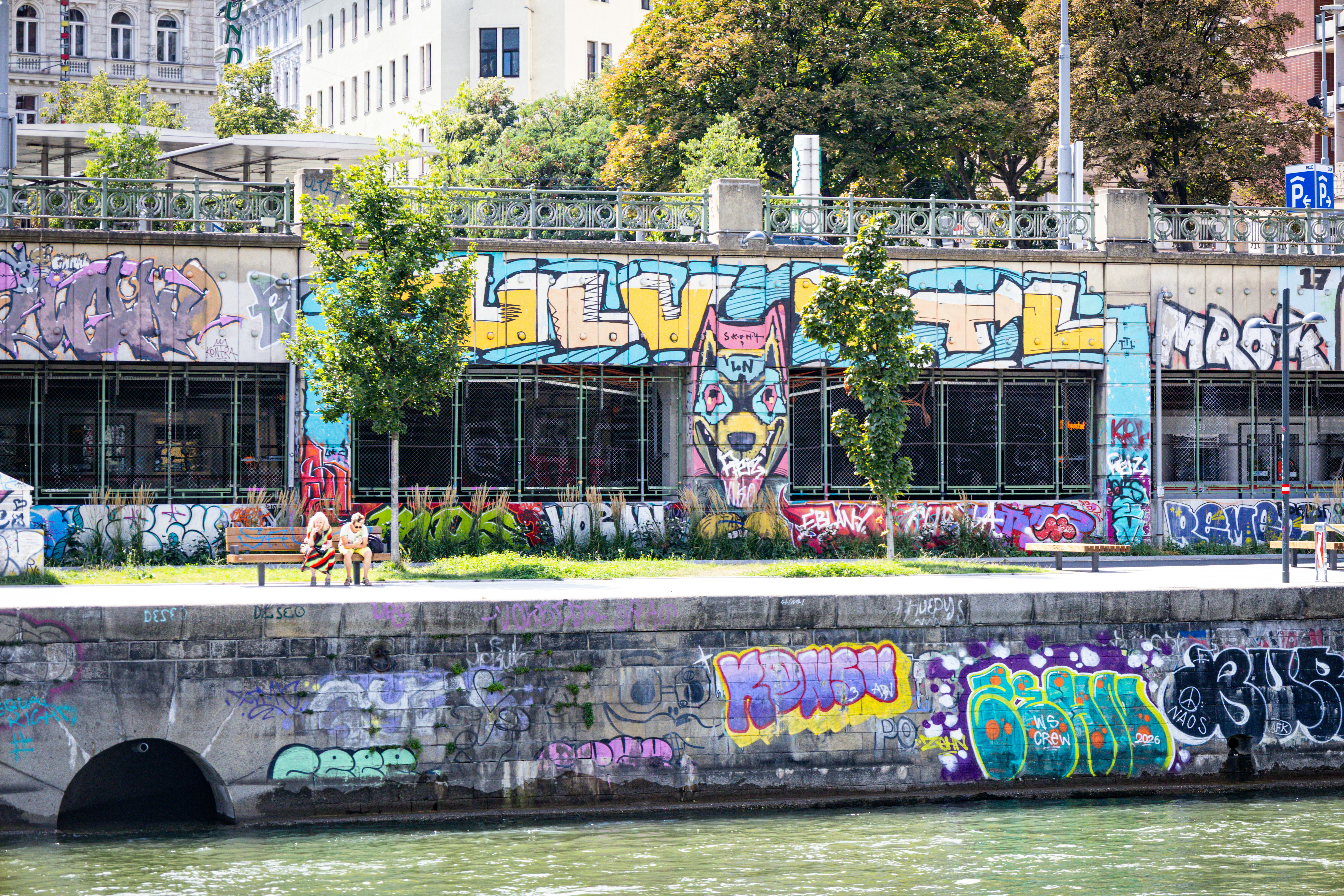 Graffiti Canal: A Colorful Facade Along the Riverside Wall