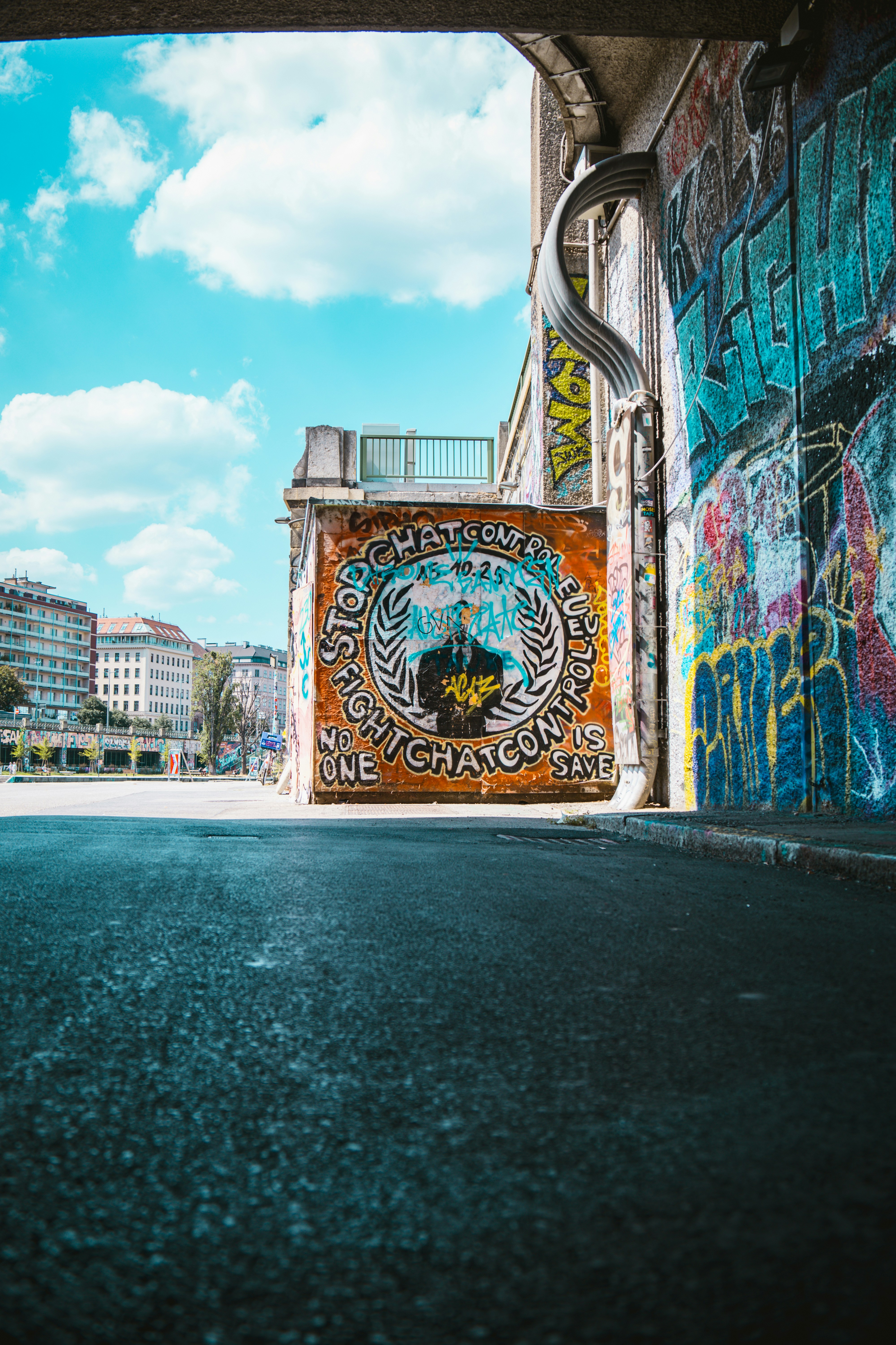 Graffiti Portal: Orange Wall Mural Framed by Alleyway Light