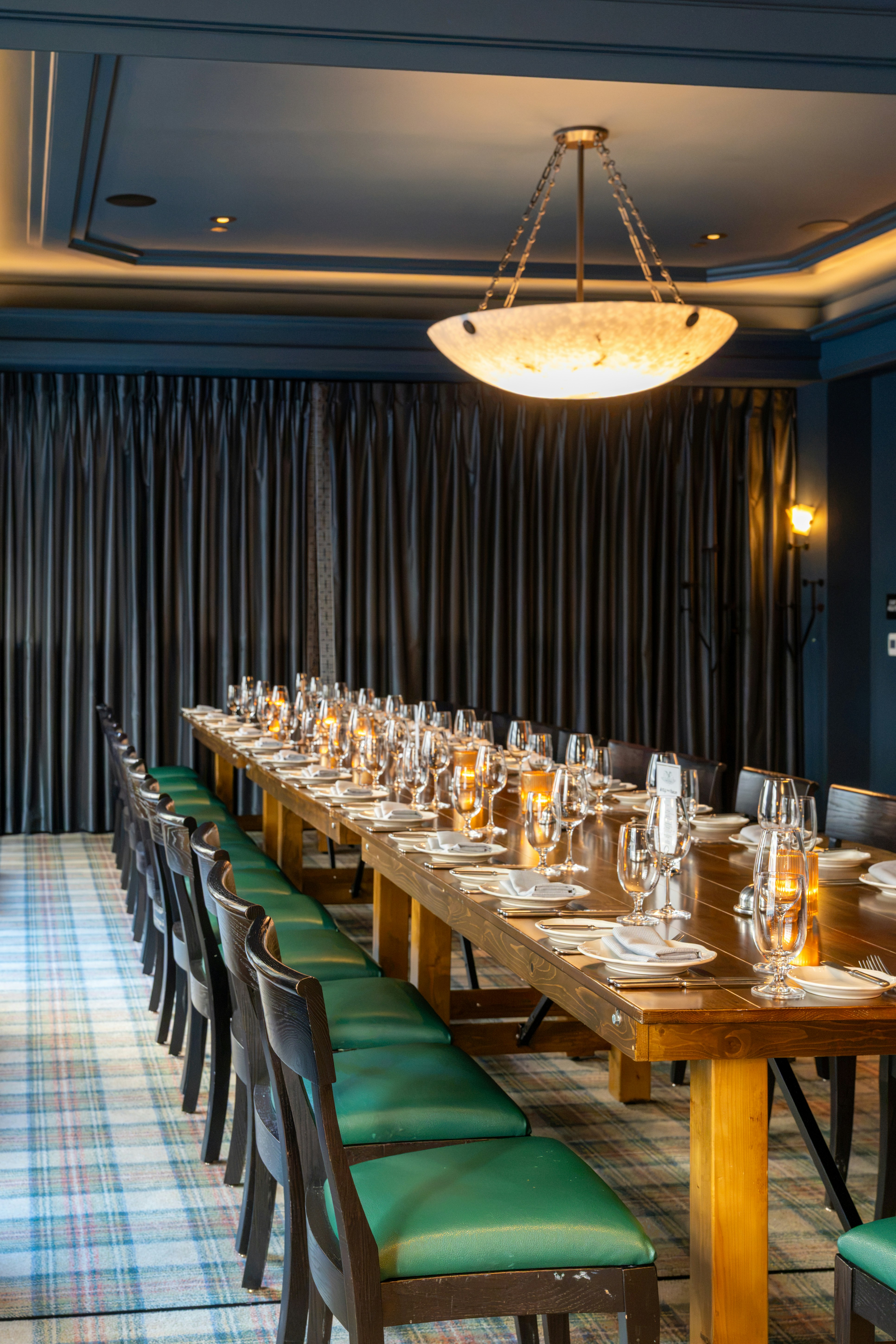 Long Dinner Table Under Warm Chandeliers