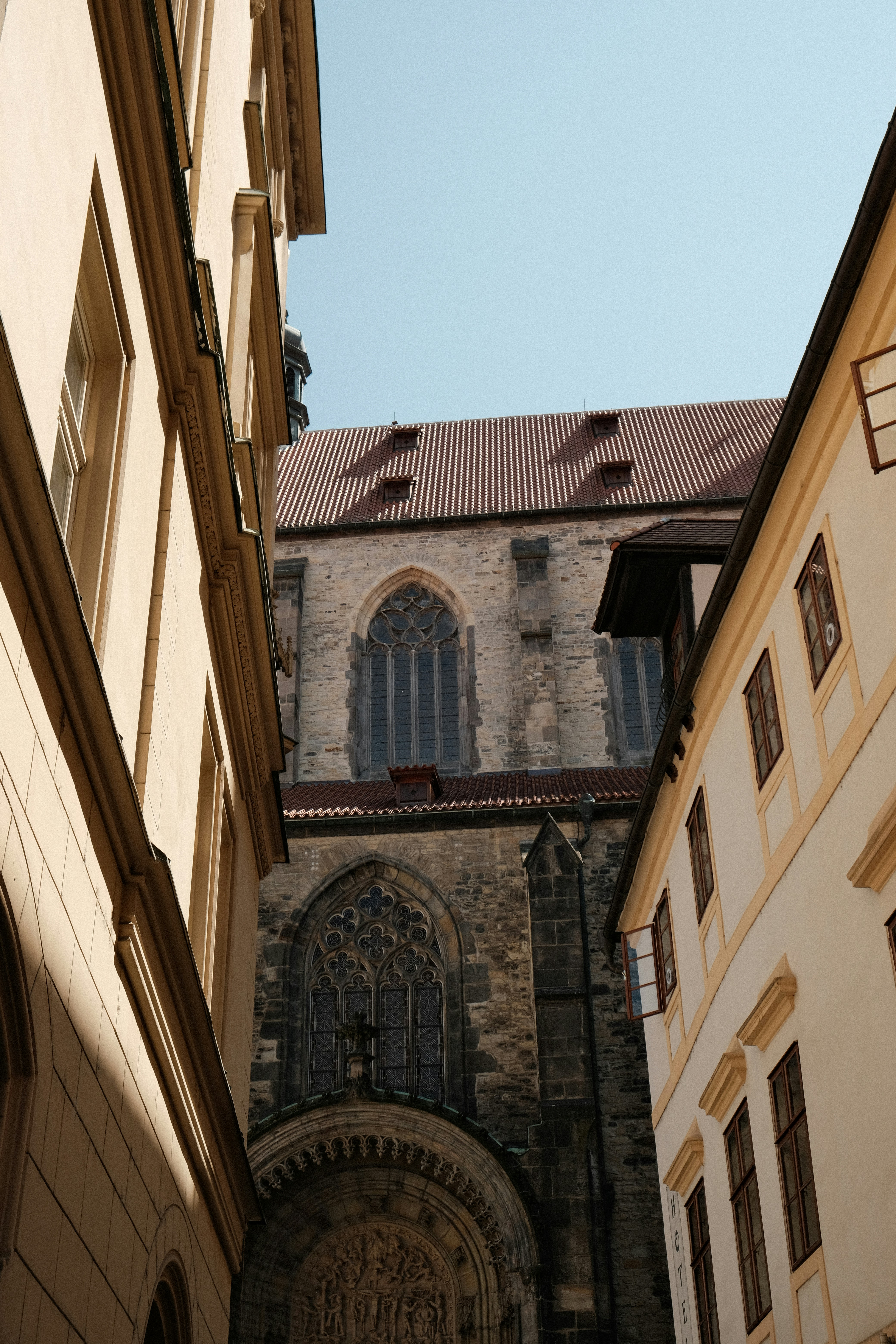 Between Courtyards: Cathedral Facade Framed by Narrow Gables