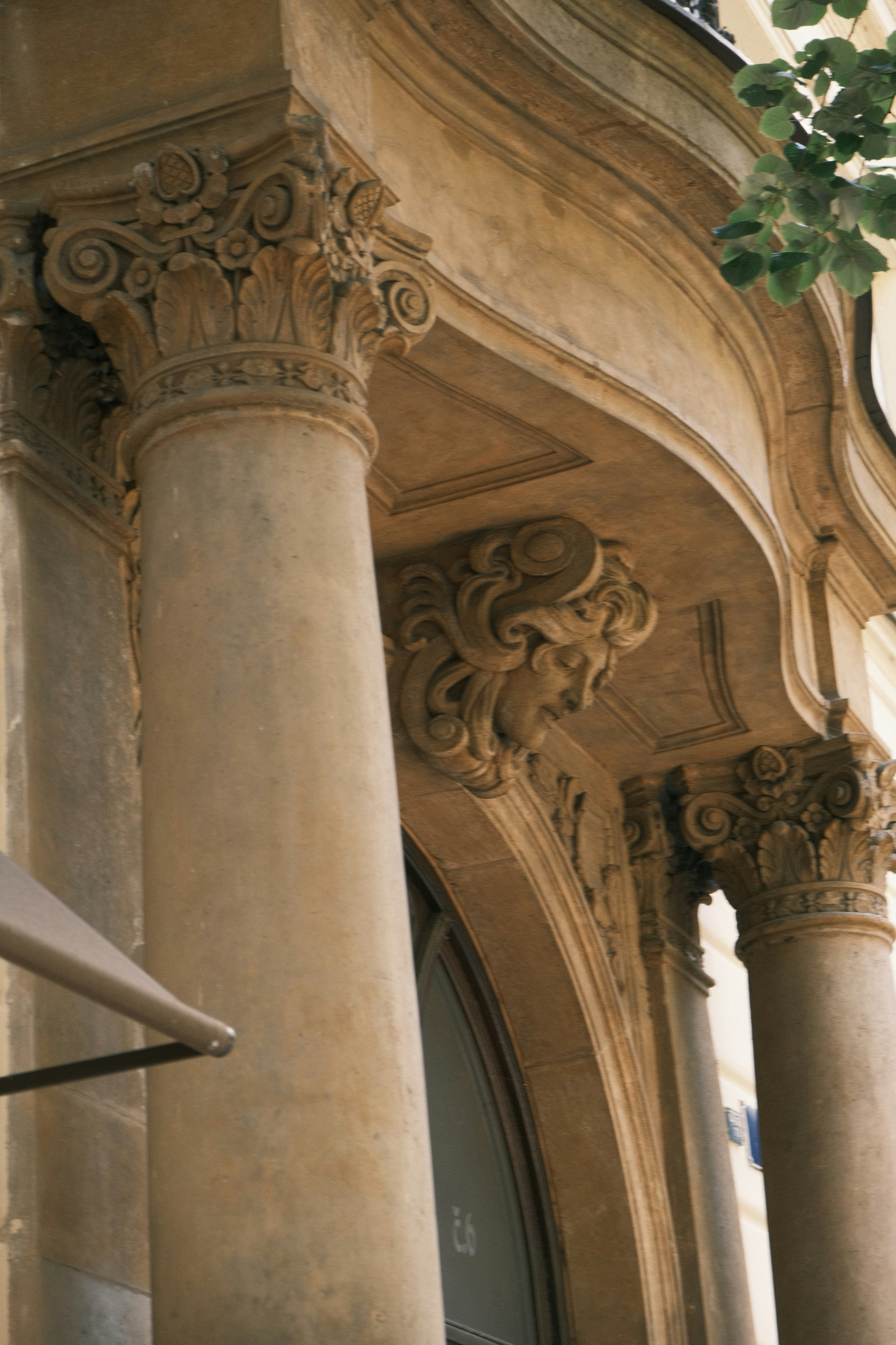 Carved Archway Portraits: A Classical Column Scene