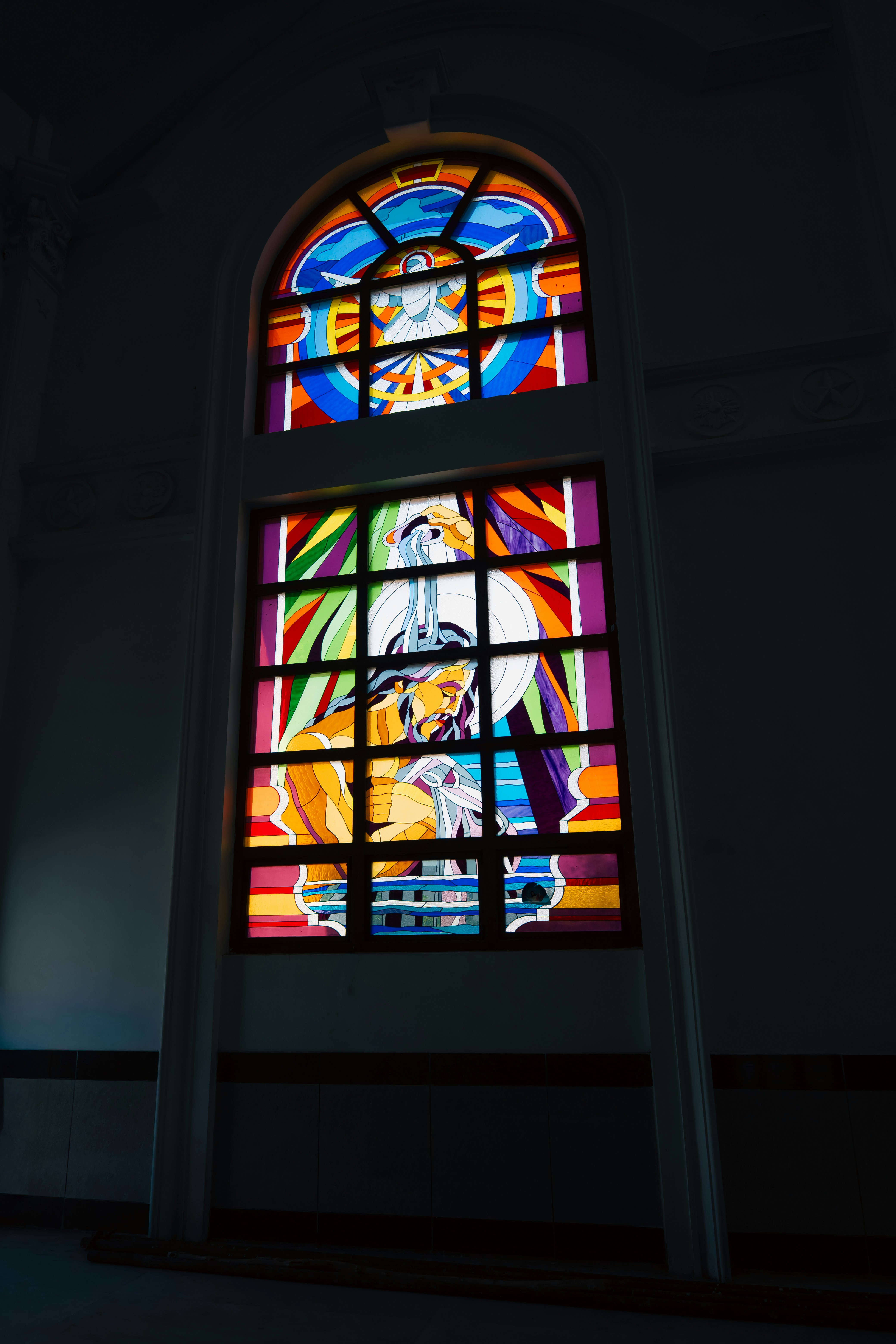 Stained Glass Cathedral Window Illuminates a Quiet Hall