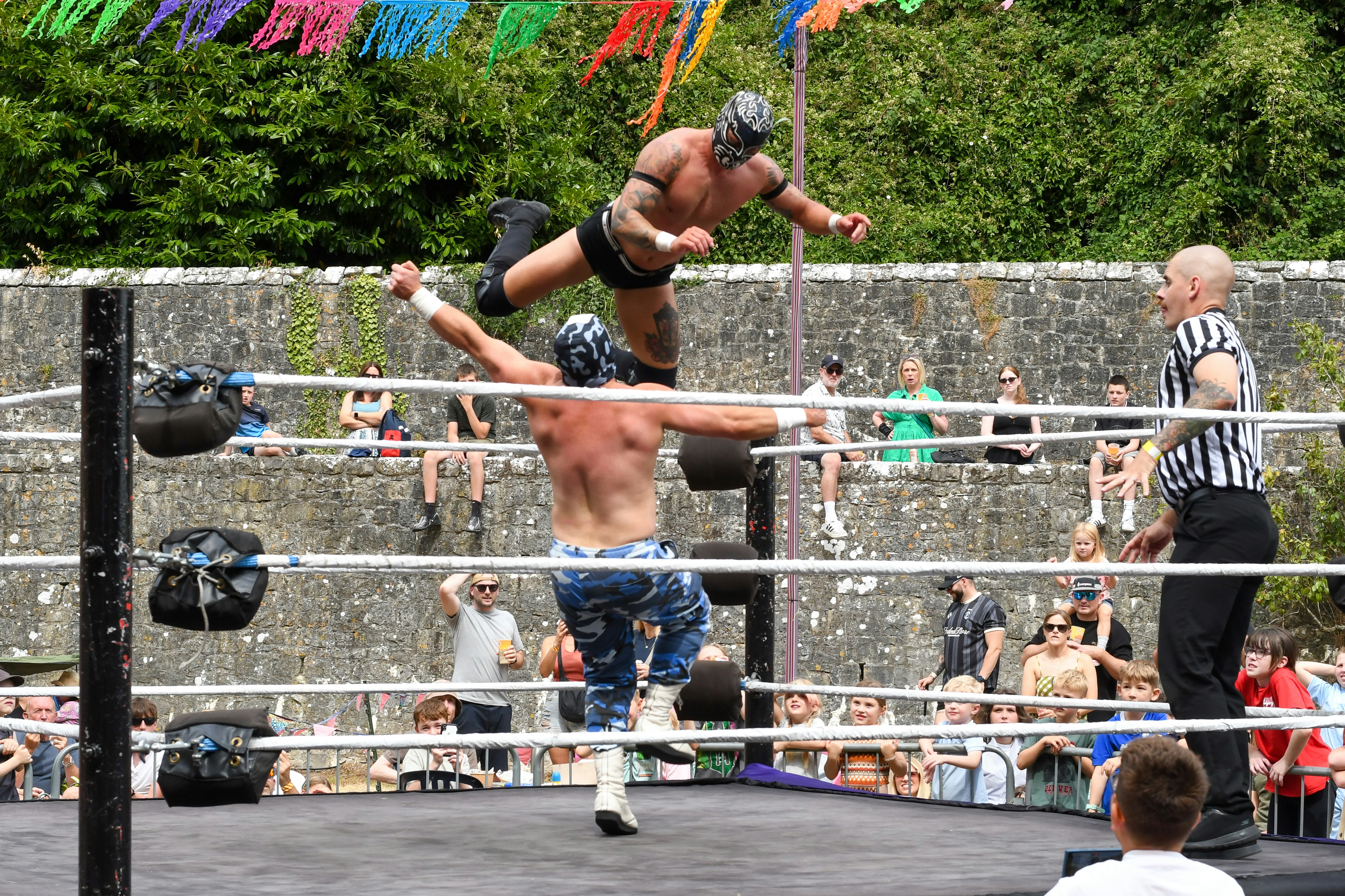 High-Flying Clash: A Wrestler Leaps Above the Ring