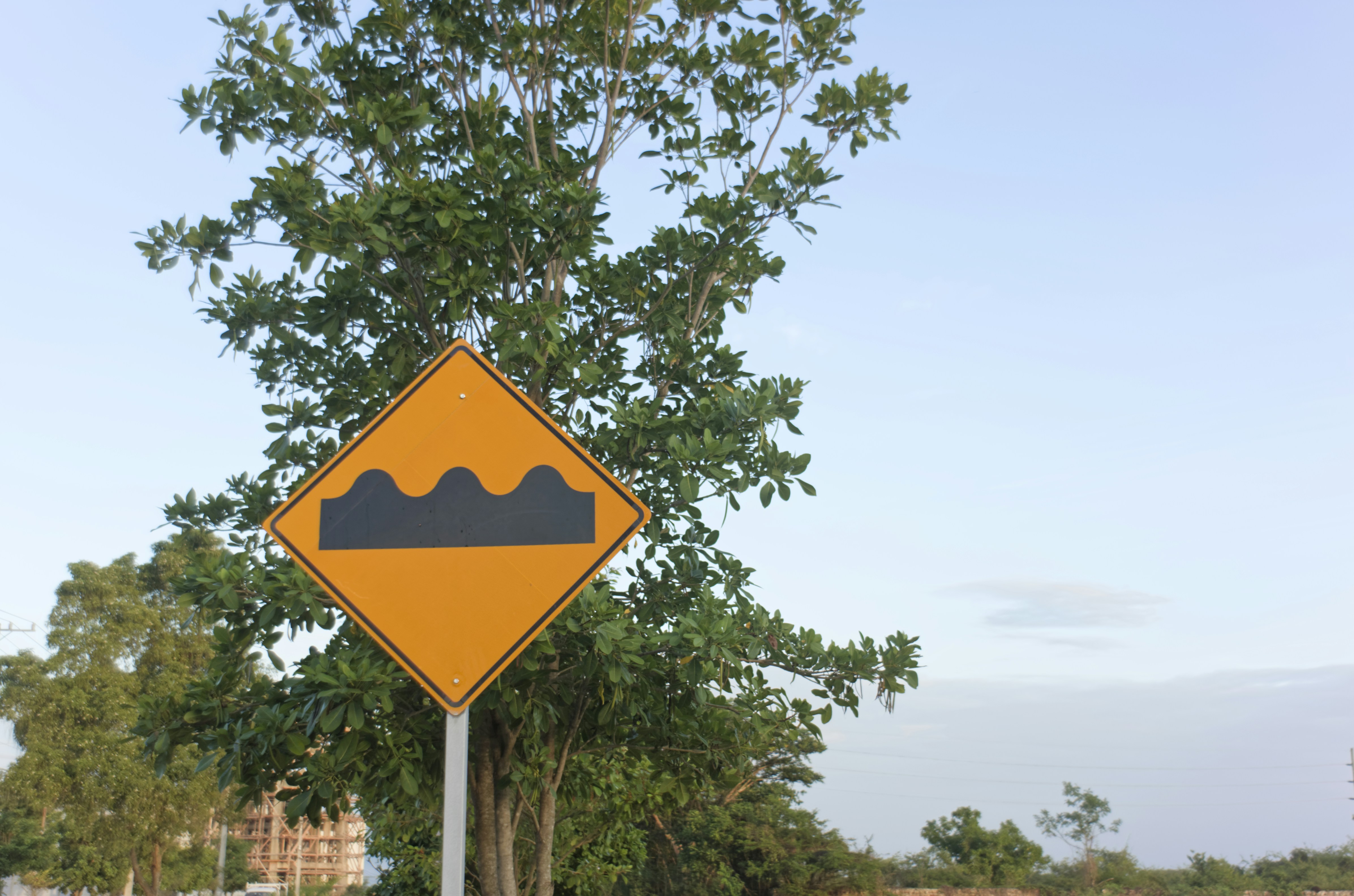 Waving Sign Above a Quiet Street