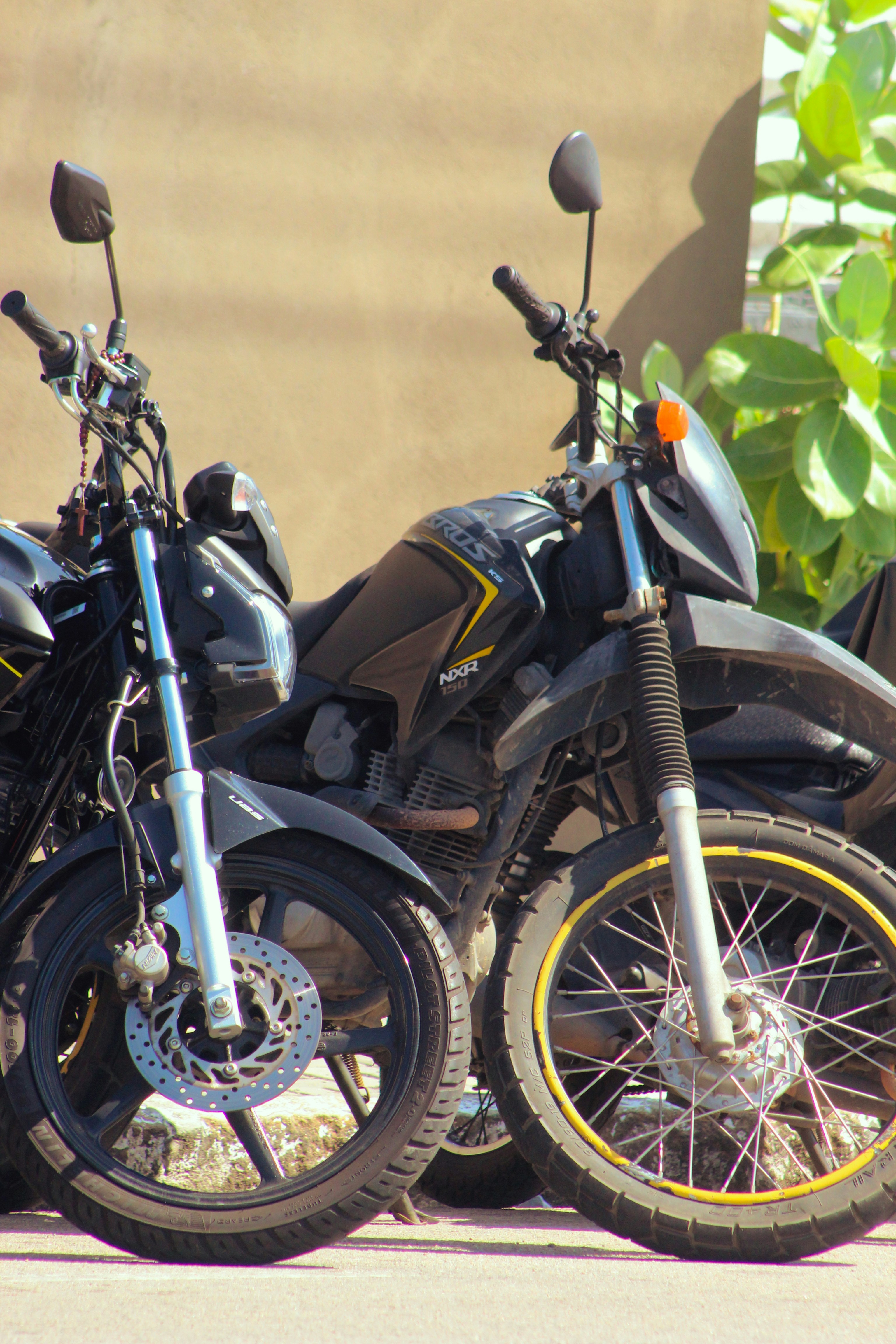 Two Motorbikes in a Row: Frontal View Highlighting Front Wheel Details