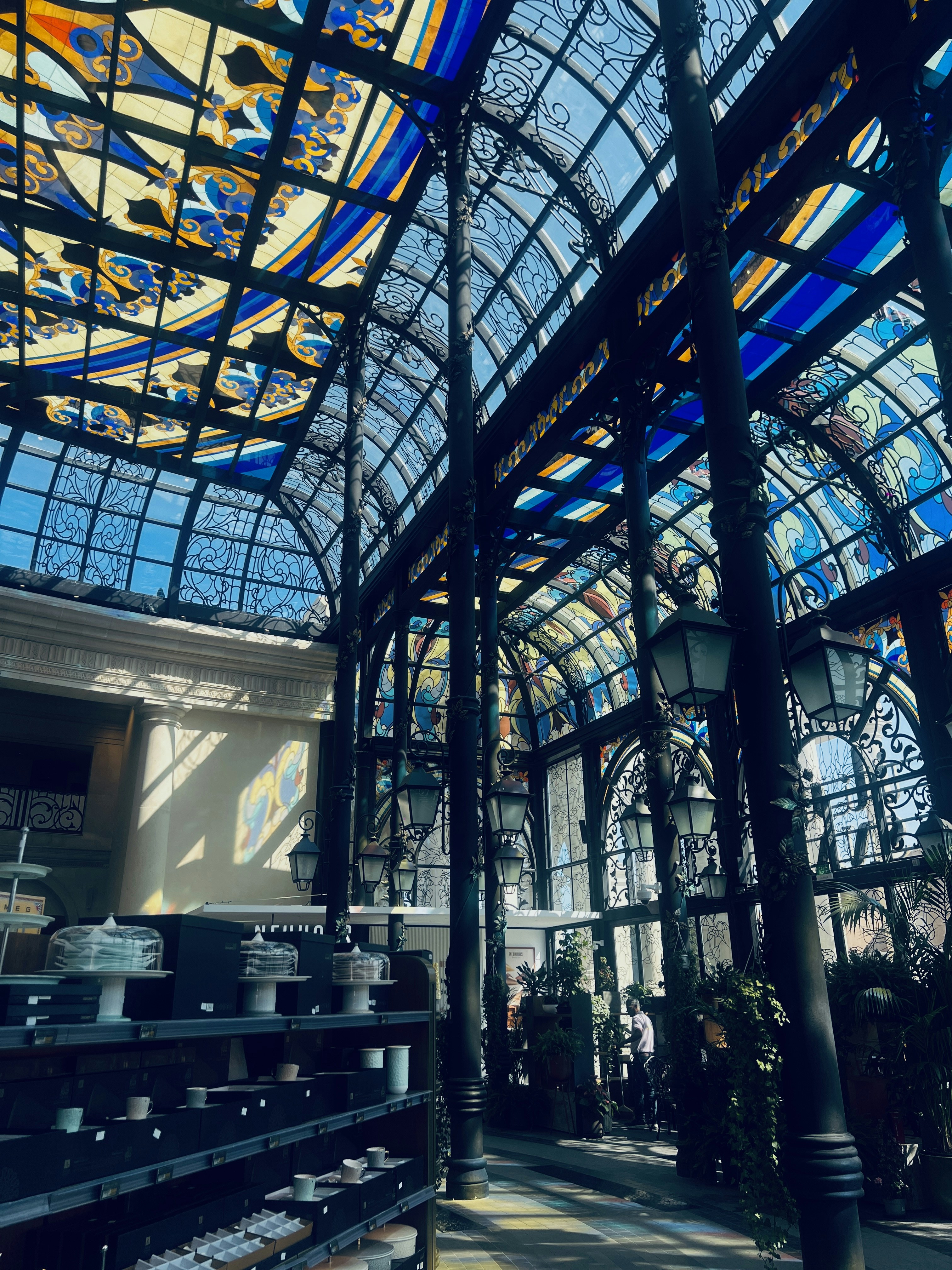 Stained-glass Arboretum: Sunlit Conservatory Beneath Iron Arches