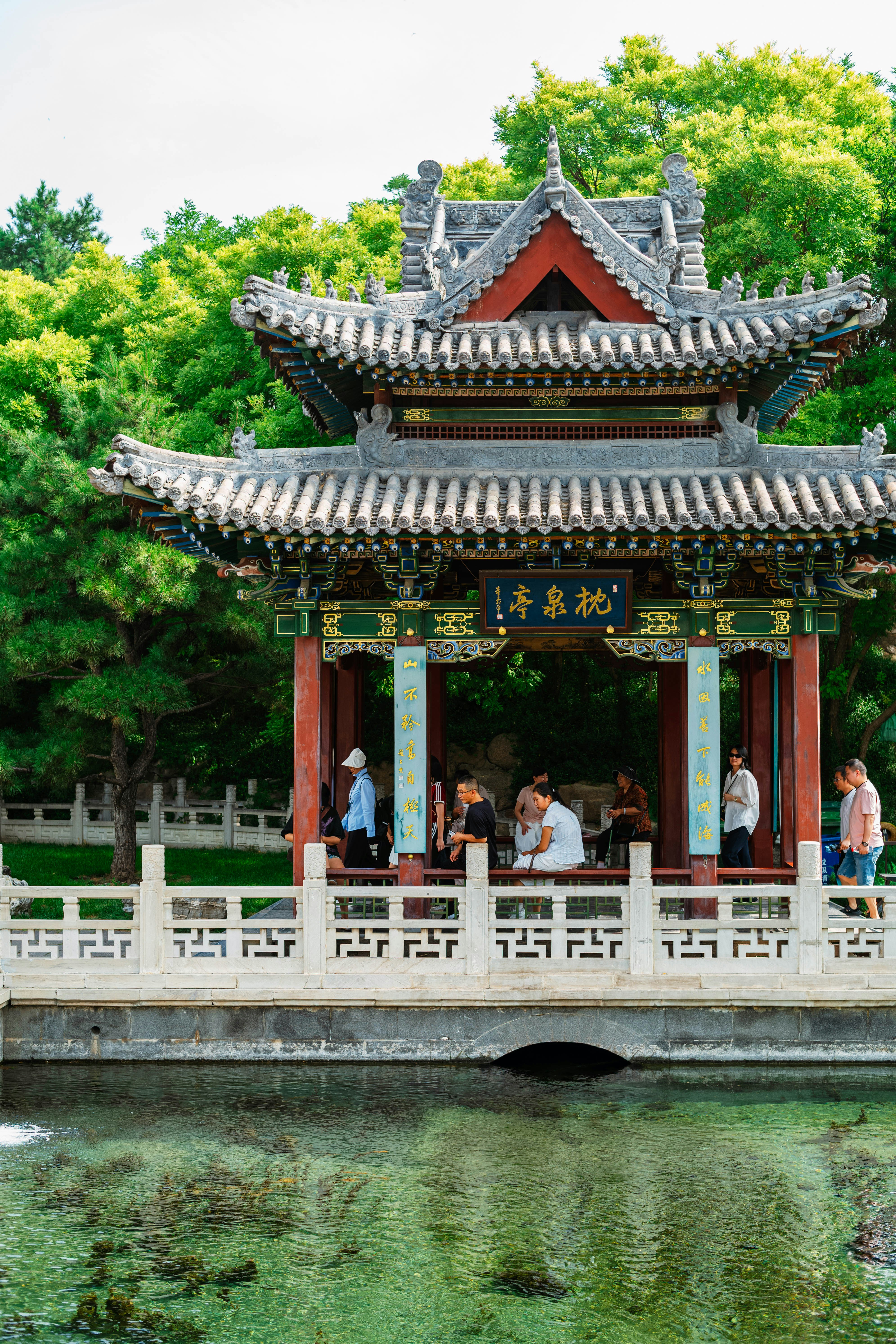 Temple Pavilion over tranquil pond: a moment beneath tiled eaves