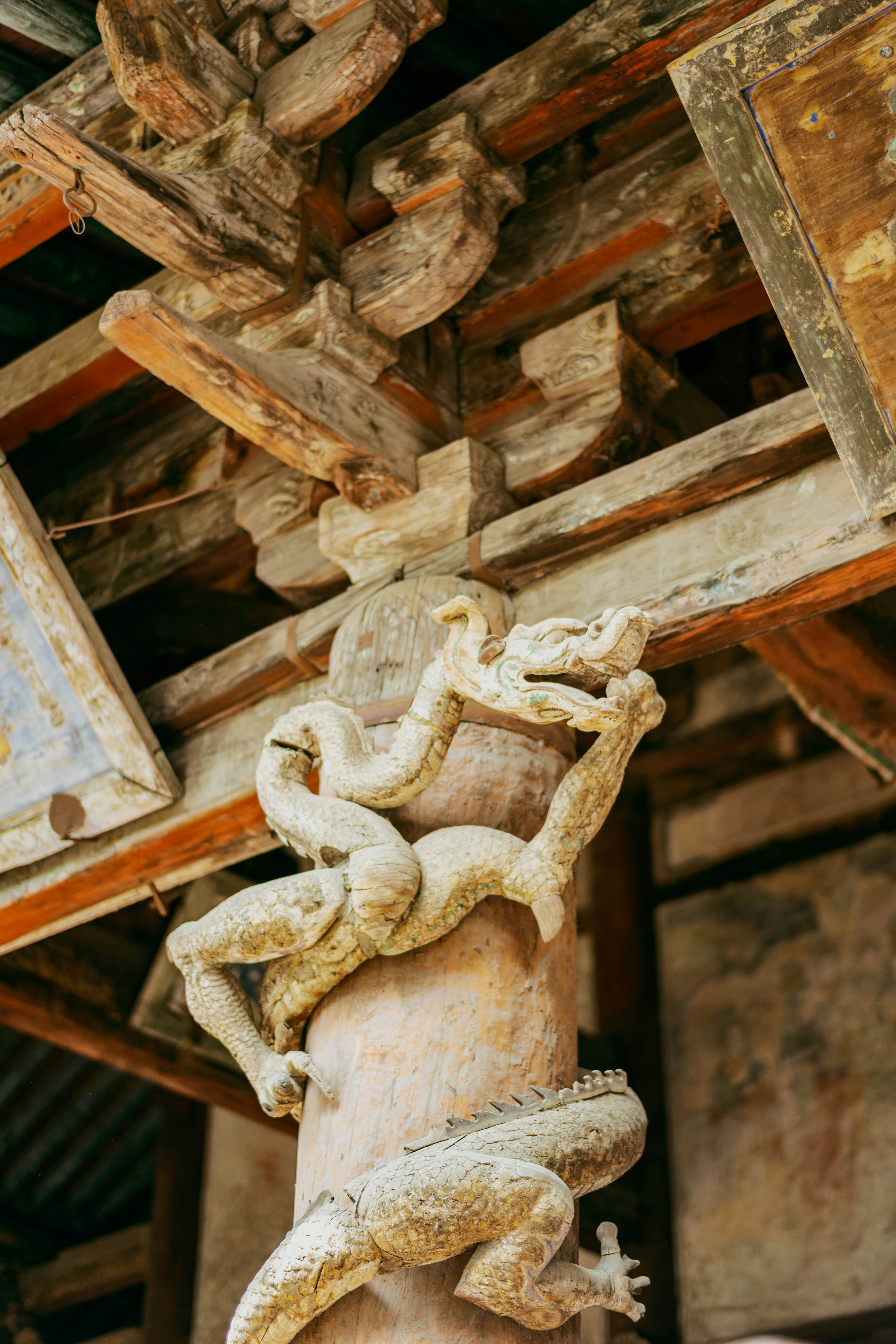 Coiled Dragon: A Weathered Carved Column Wrapped in Ancient Serpents