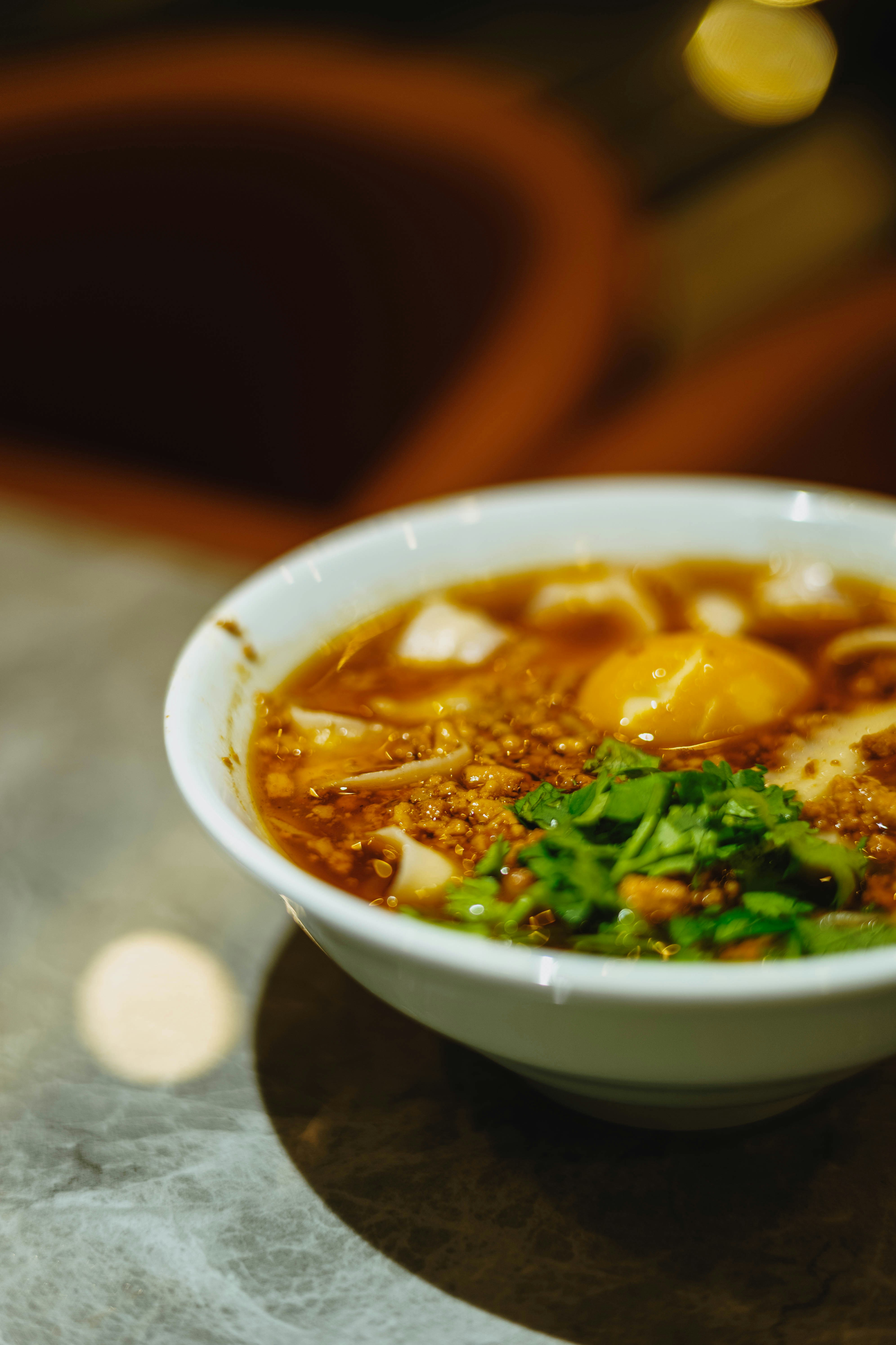 Savory Bowl: Rich Broth and Fresh Greens in a Steamy Moment