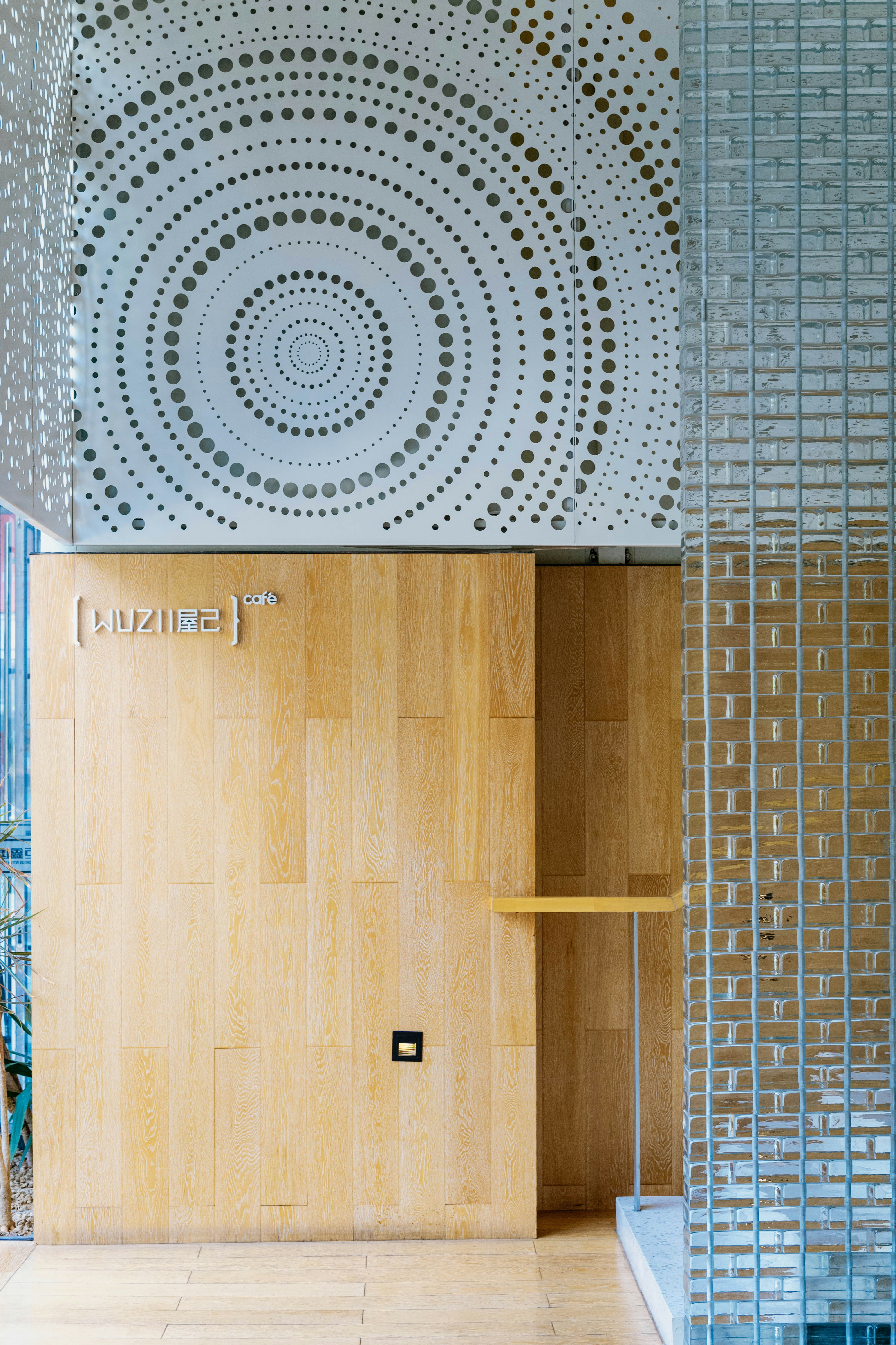 Circular pattern meets wooden façade: a minimal urban interior