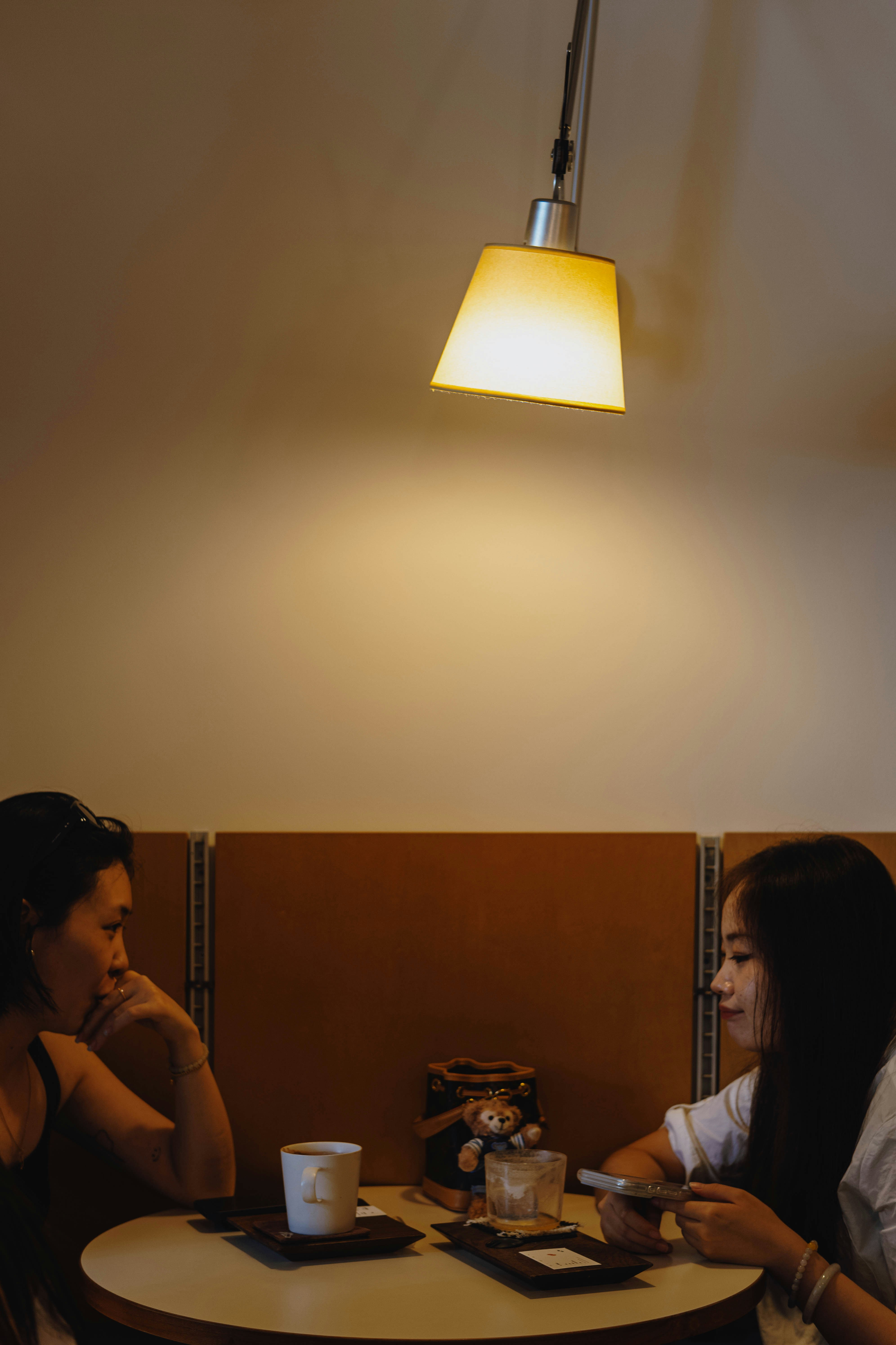 Quiet Dialogue Over Coffee: Two Friends in the Warm Glow