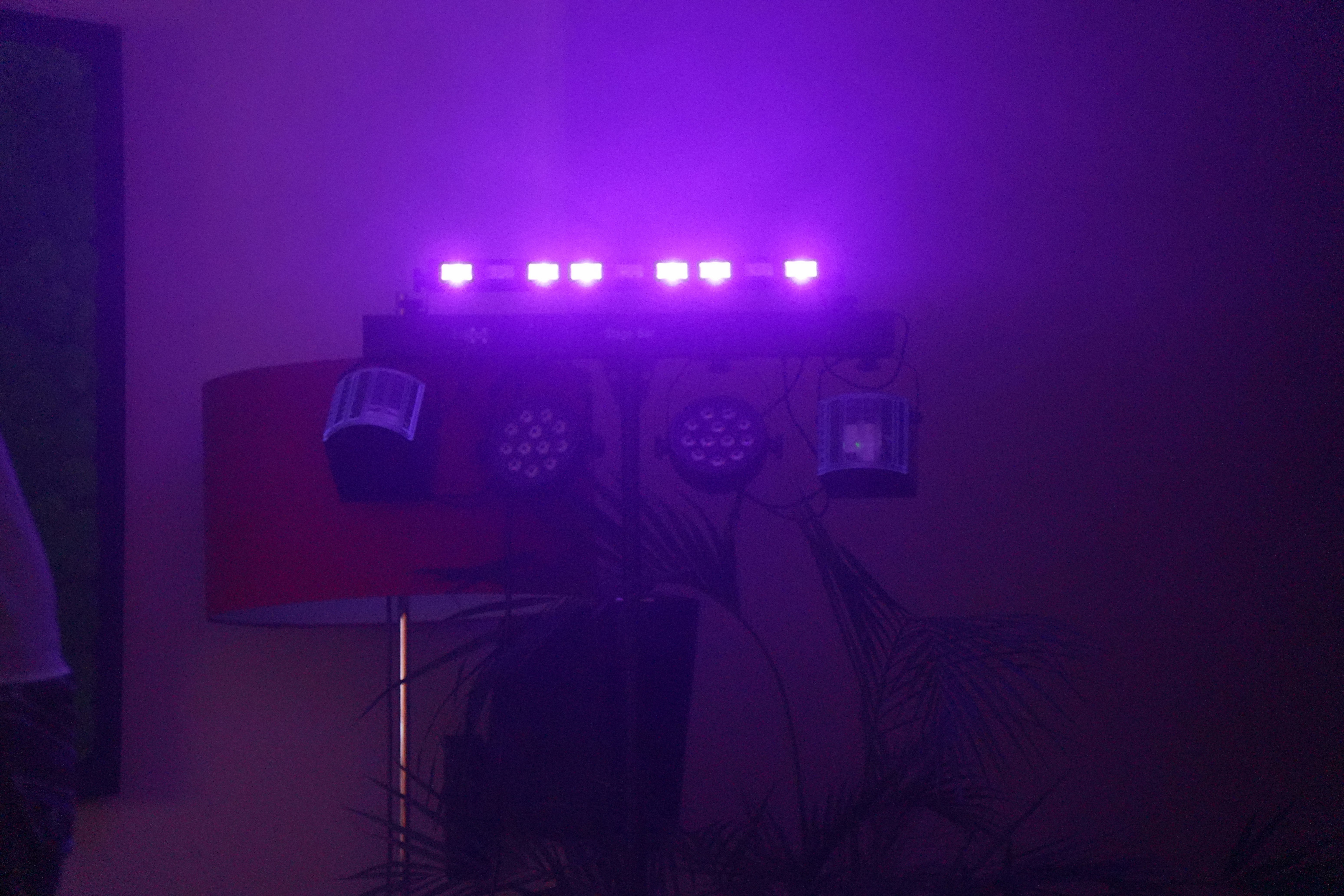 Neon Bloom: Purple LED Bar Over a Dark Room