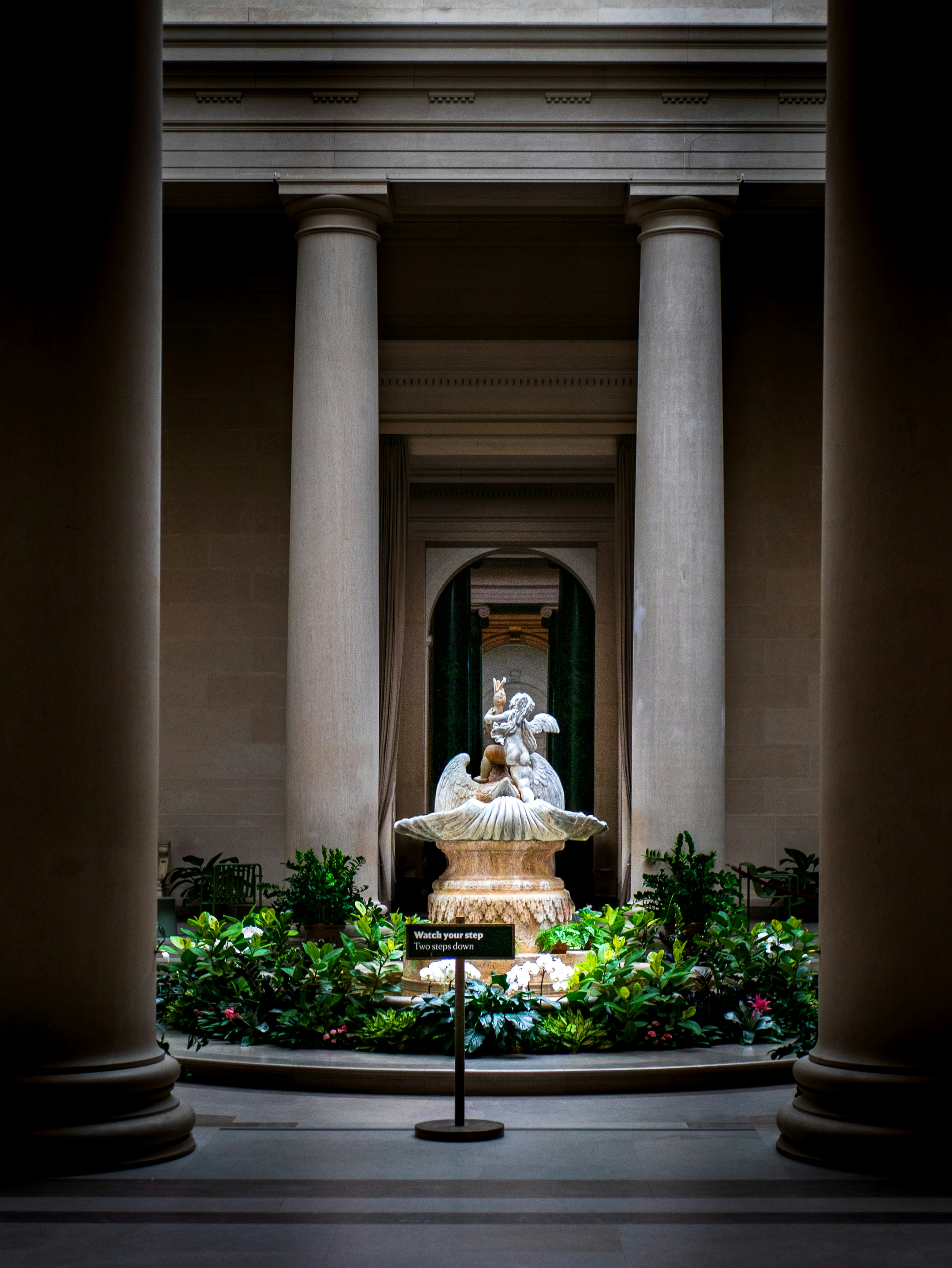 A Marble Oasis: Angelic Sculpture Framed by Classical Colonnades