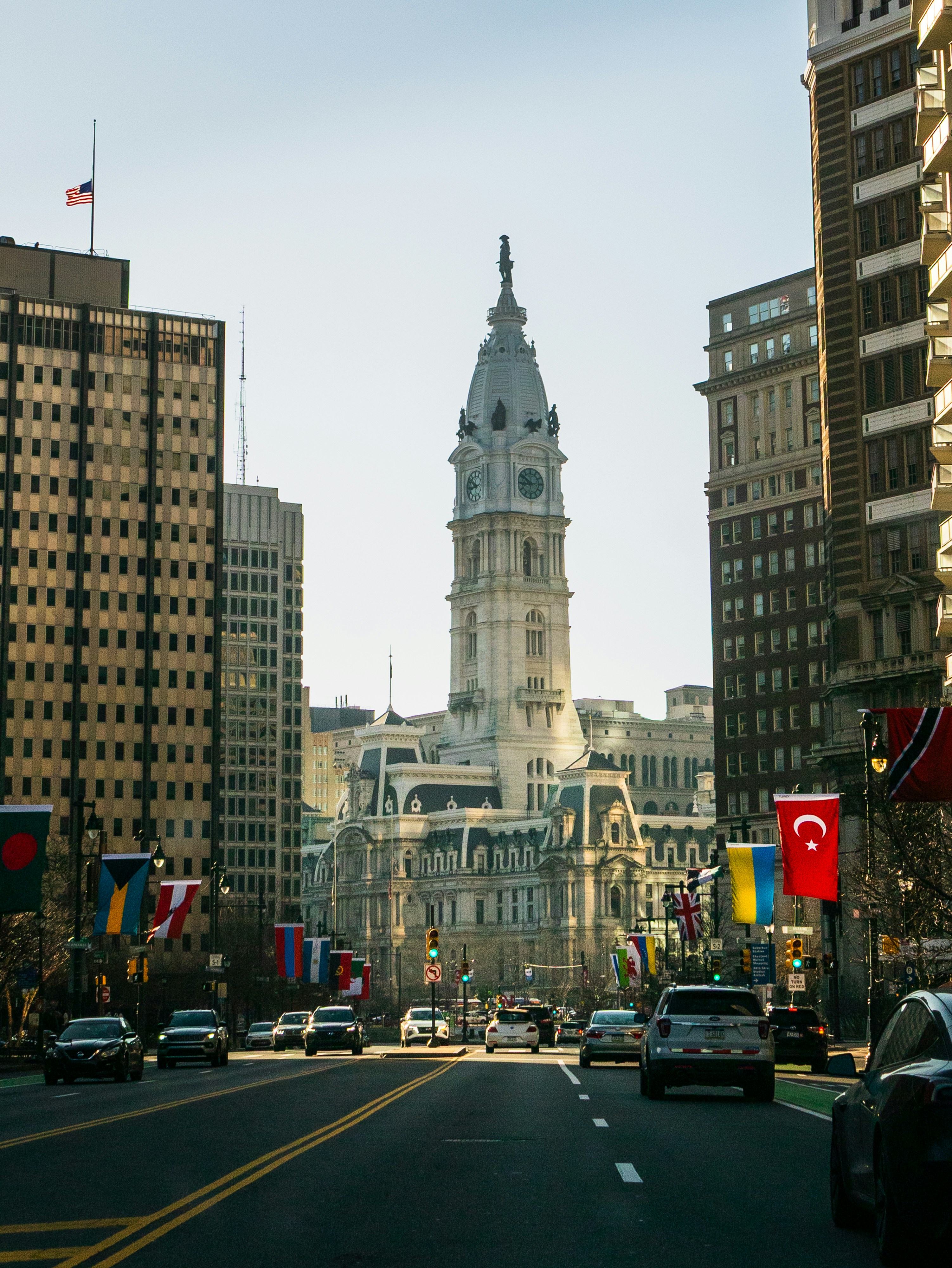 Clock Tower Sentinel Over a Flags-Lined City Street