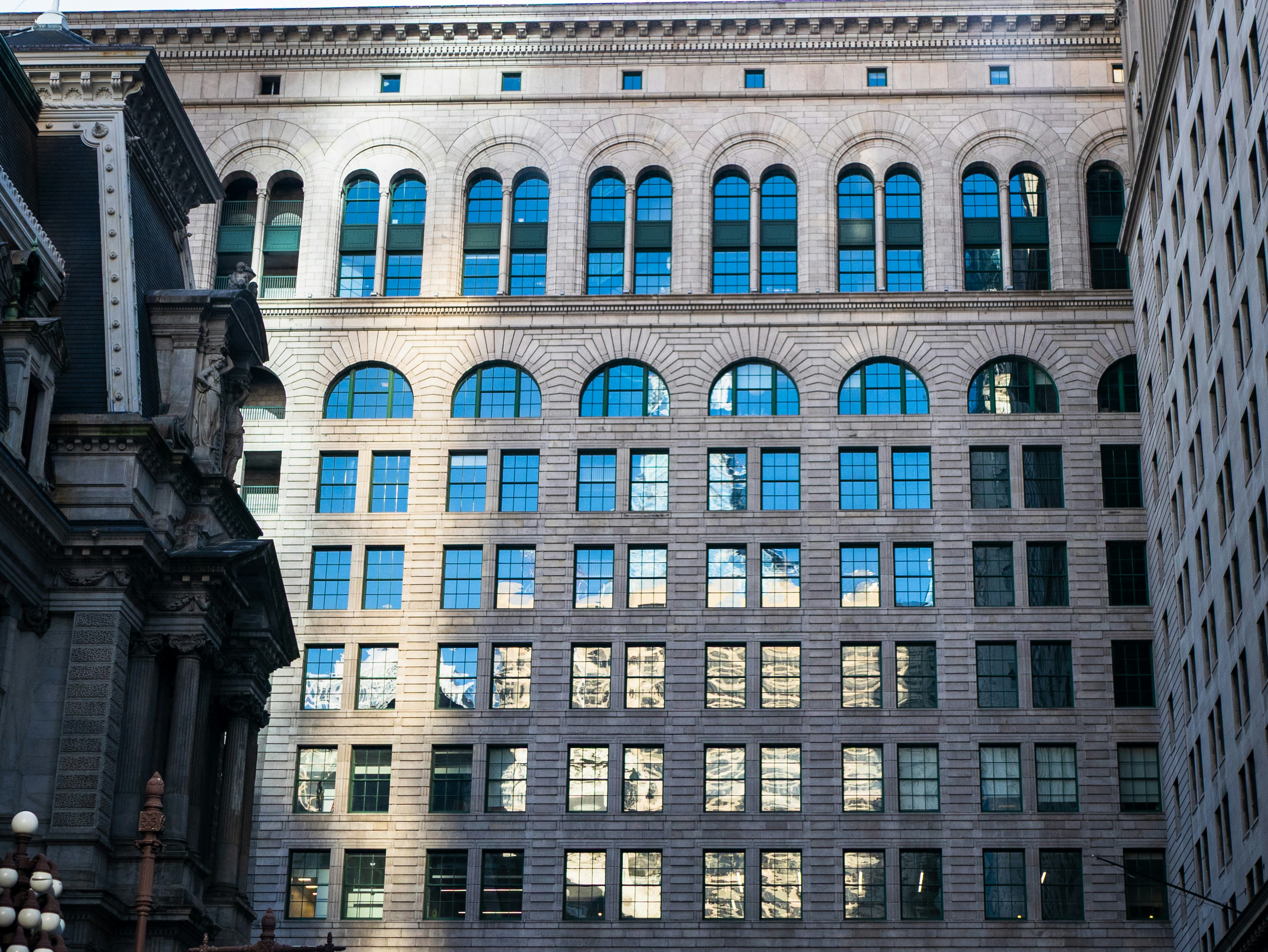 Sunlit Arches: A Cathedral of Windows Reflected in Steel and Stone