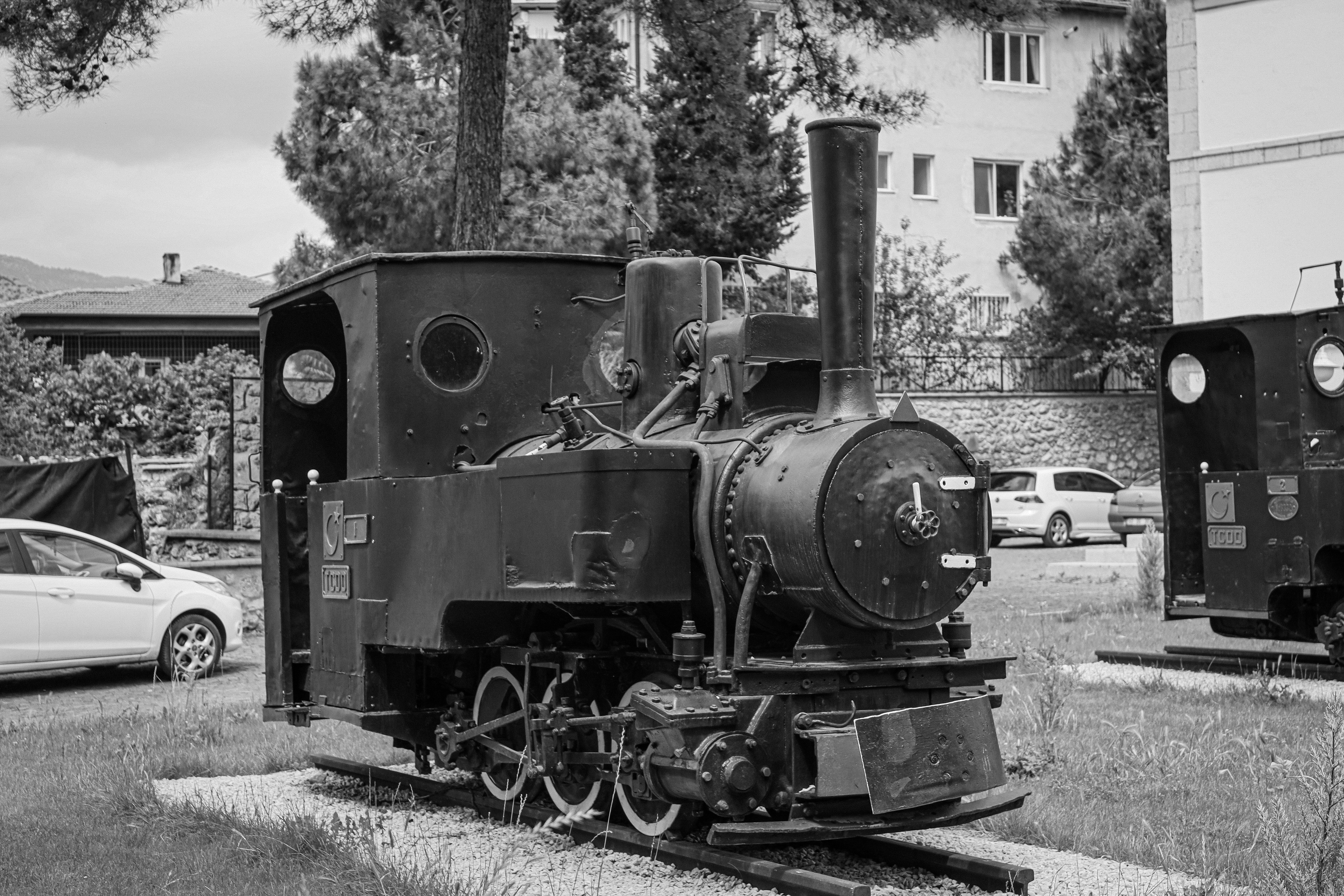 Steam on Soft Grays: A Historic Locomotive Resting in the Yard