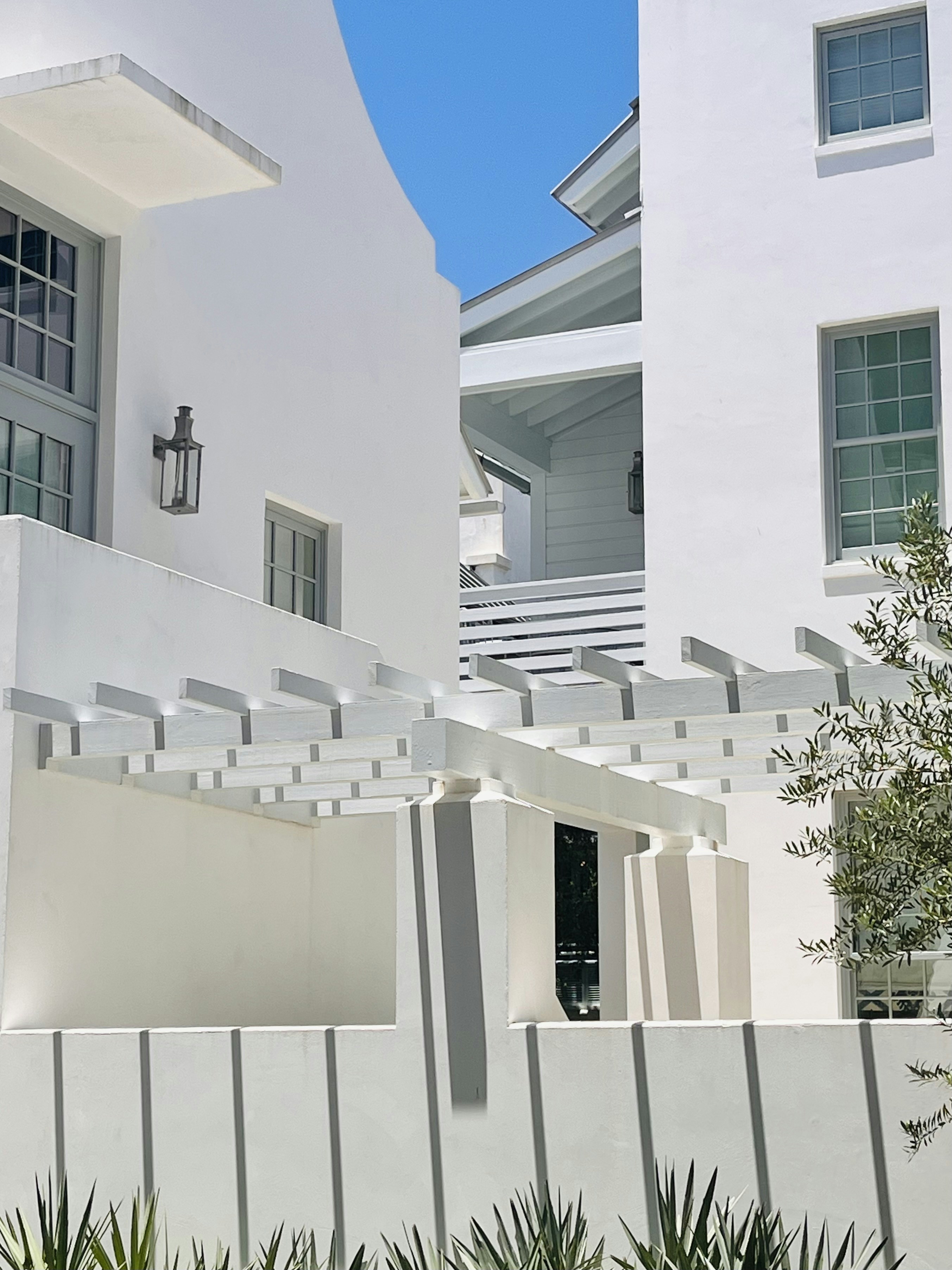 White Architectural Quiet: Sunlit Facades and Pergola Shadows
