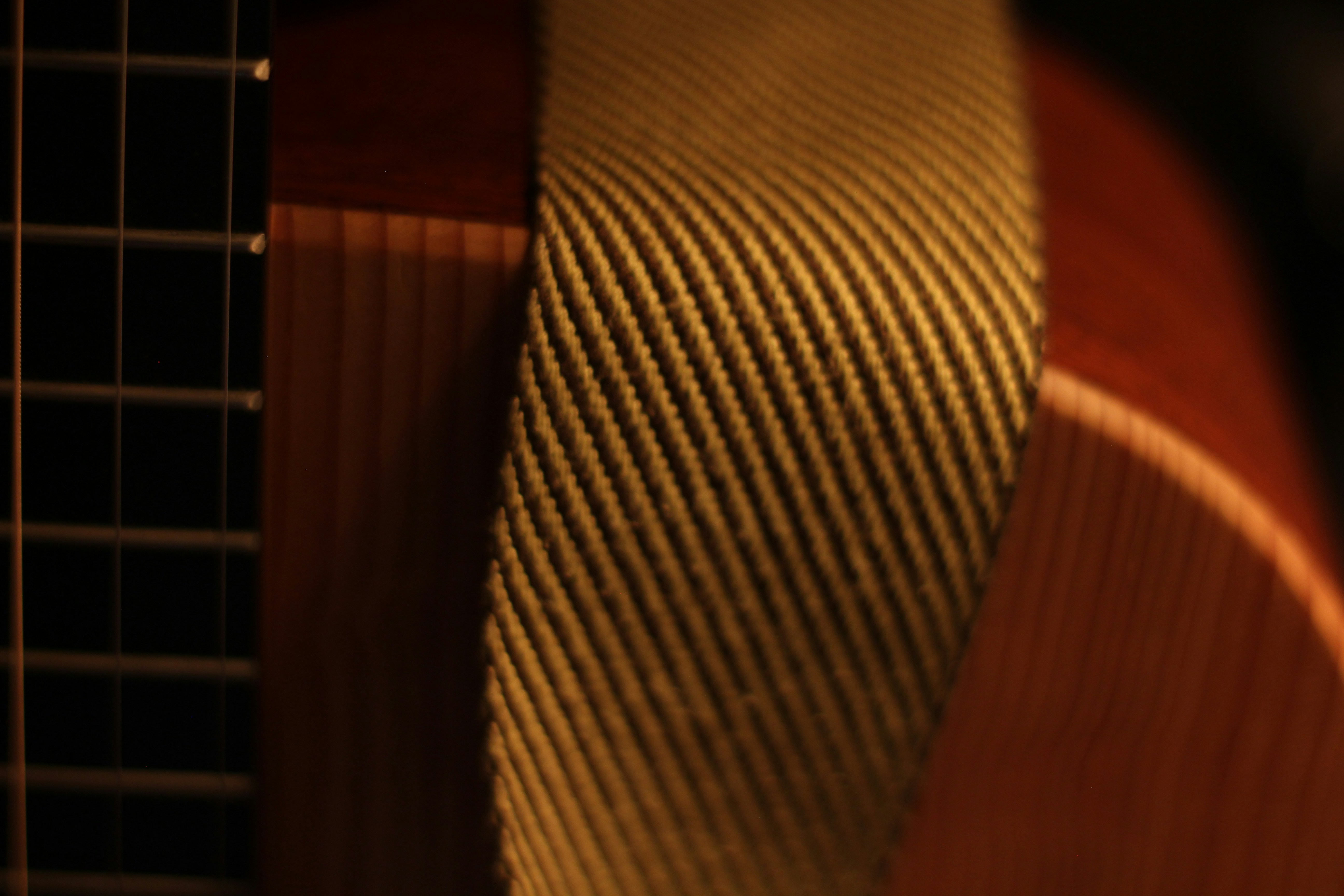 Threads of Sound: The Guitars Straps and Strings in Ember Light