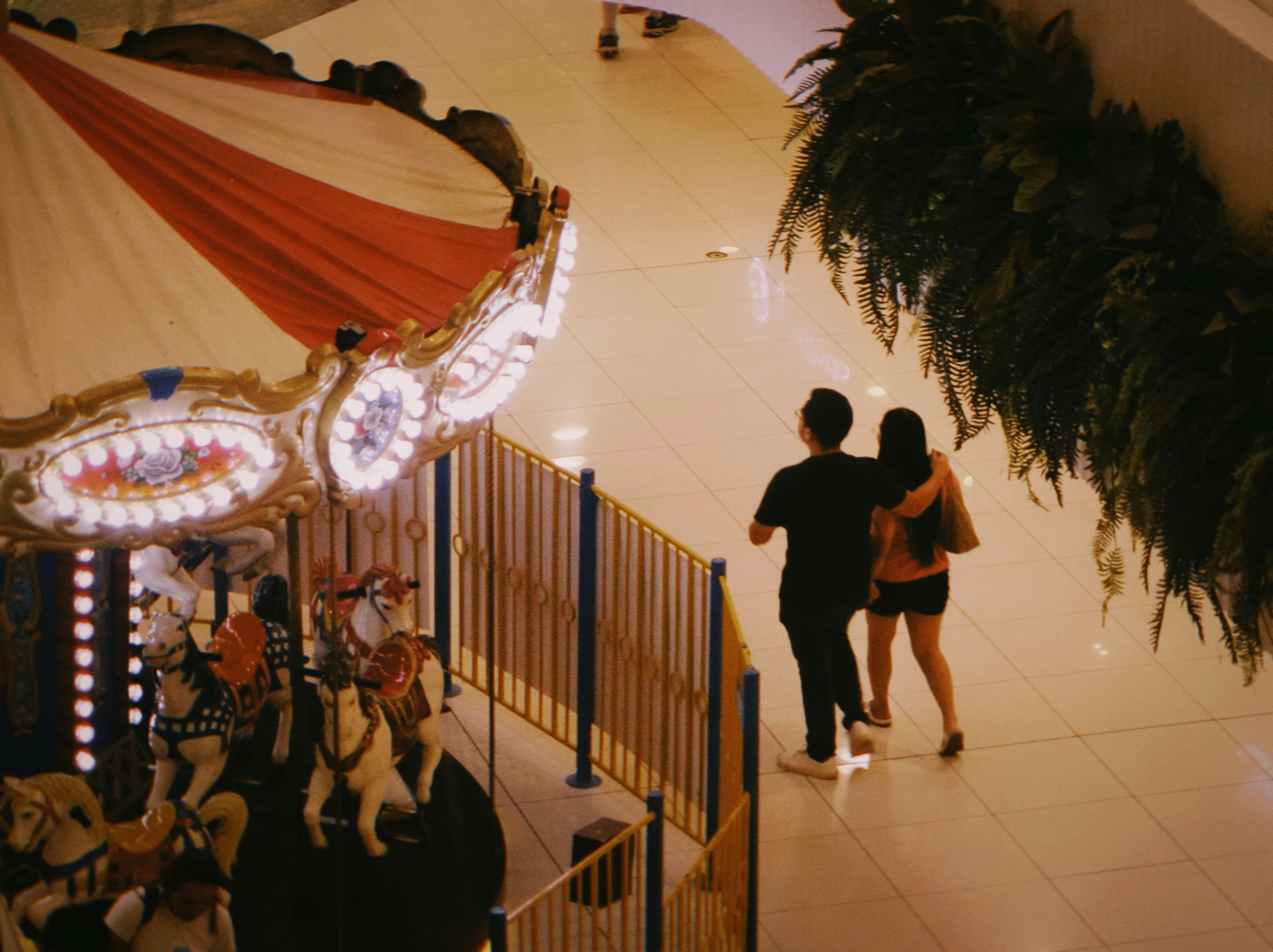 Carousel Lights and Couple in a Mall Walkway