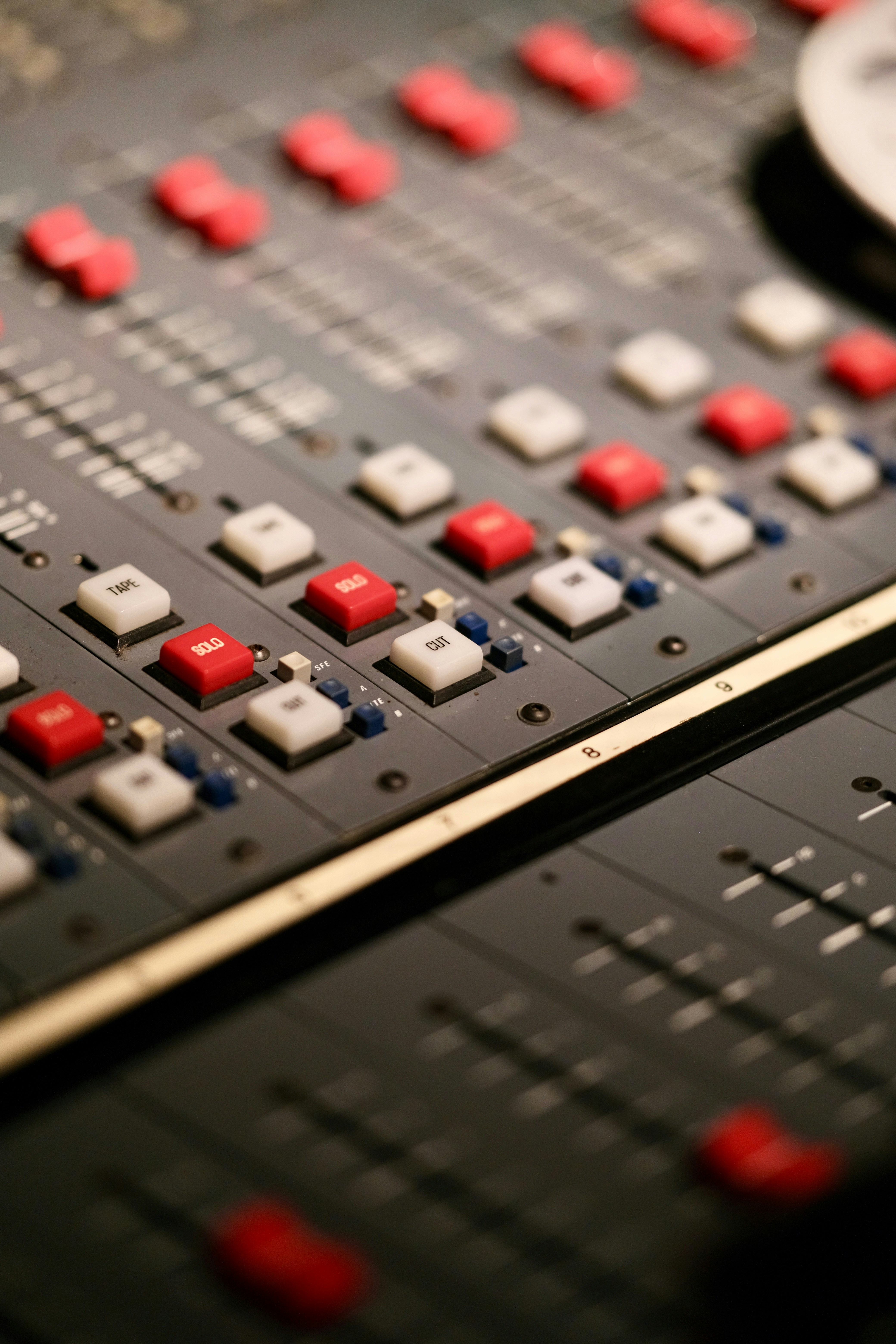 Control Surface in Focus: A Close-up of an Analog Audio Mixer