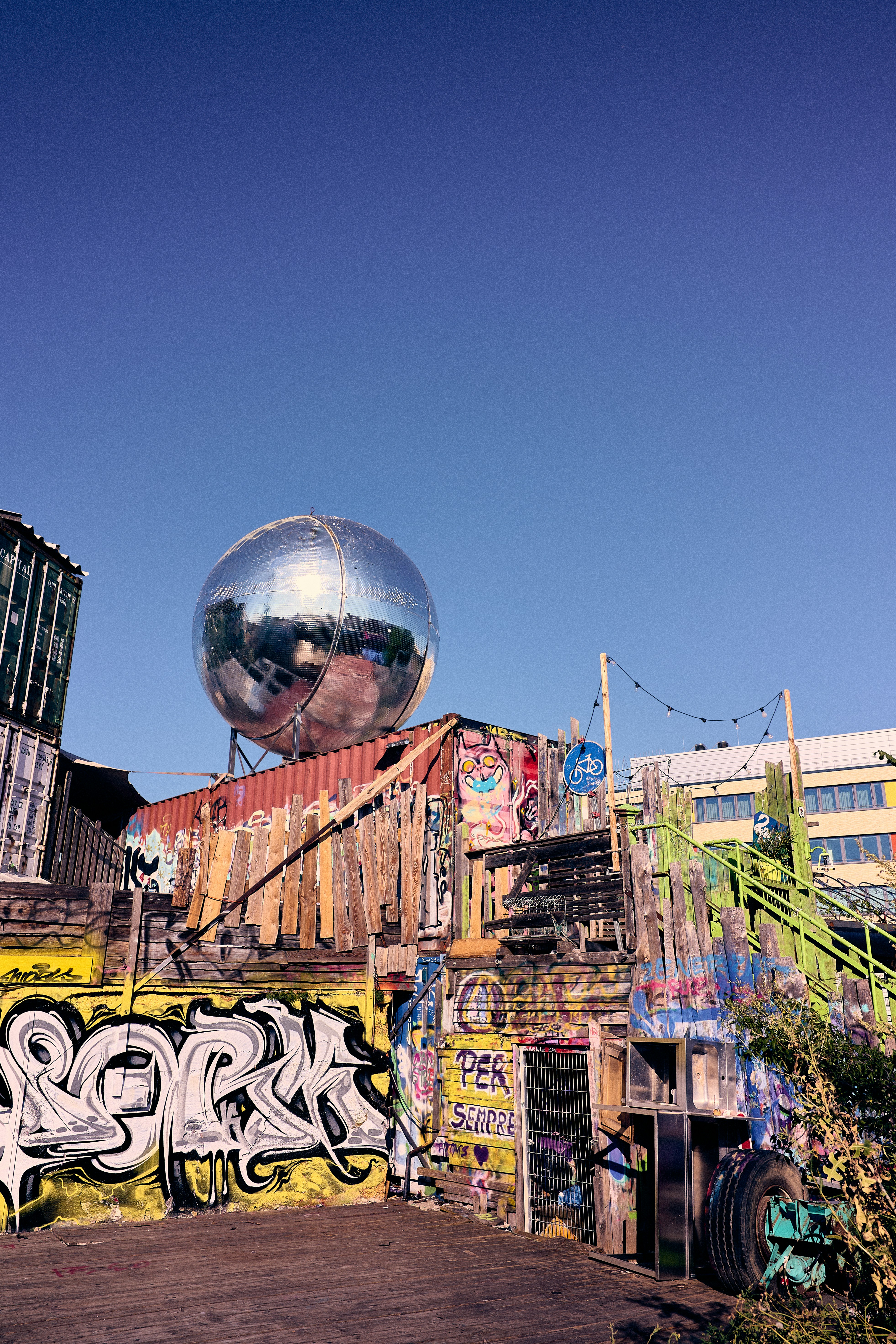 Reflections on a Graffiti Sky: A metallic globe over urban art