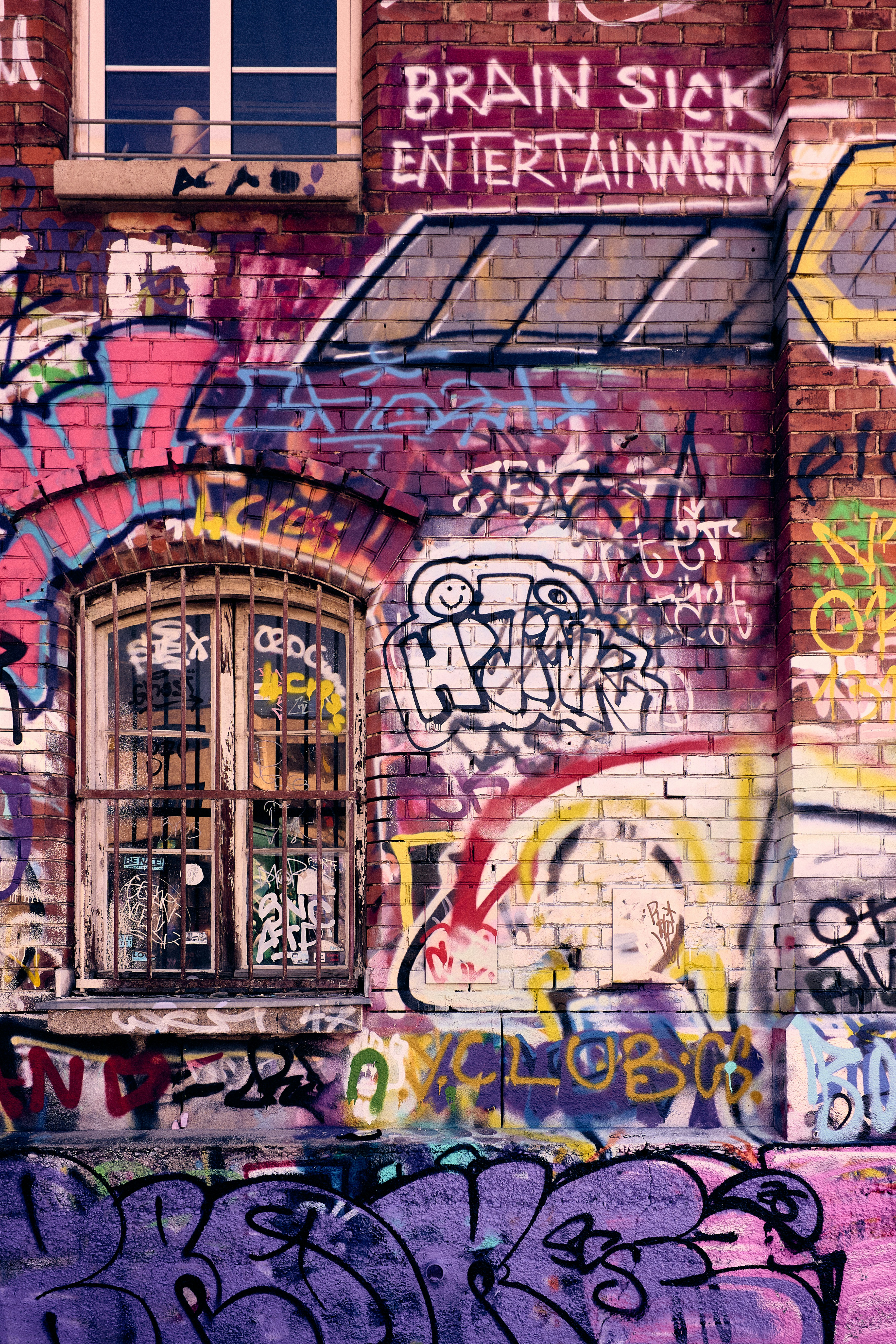 Brick Canvas: A Window into Urban Graffiti and Colorful Layers