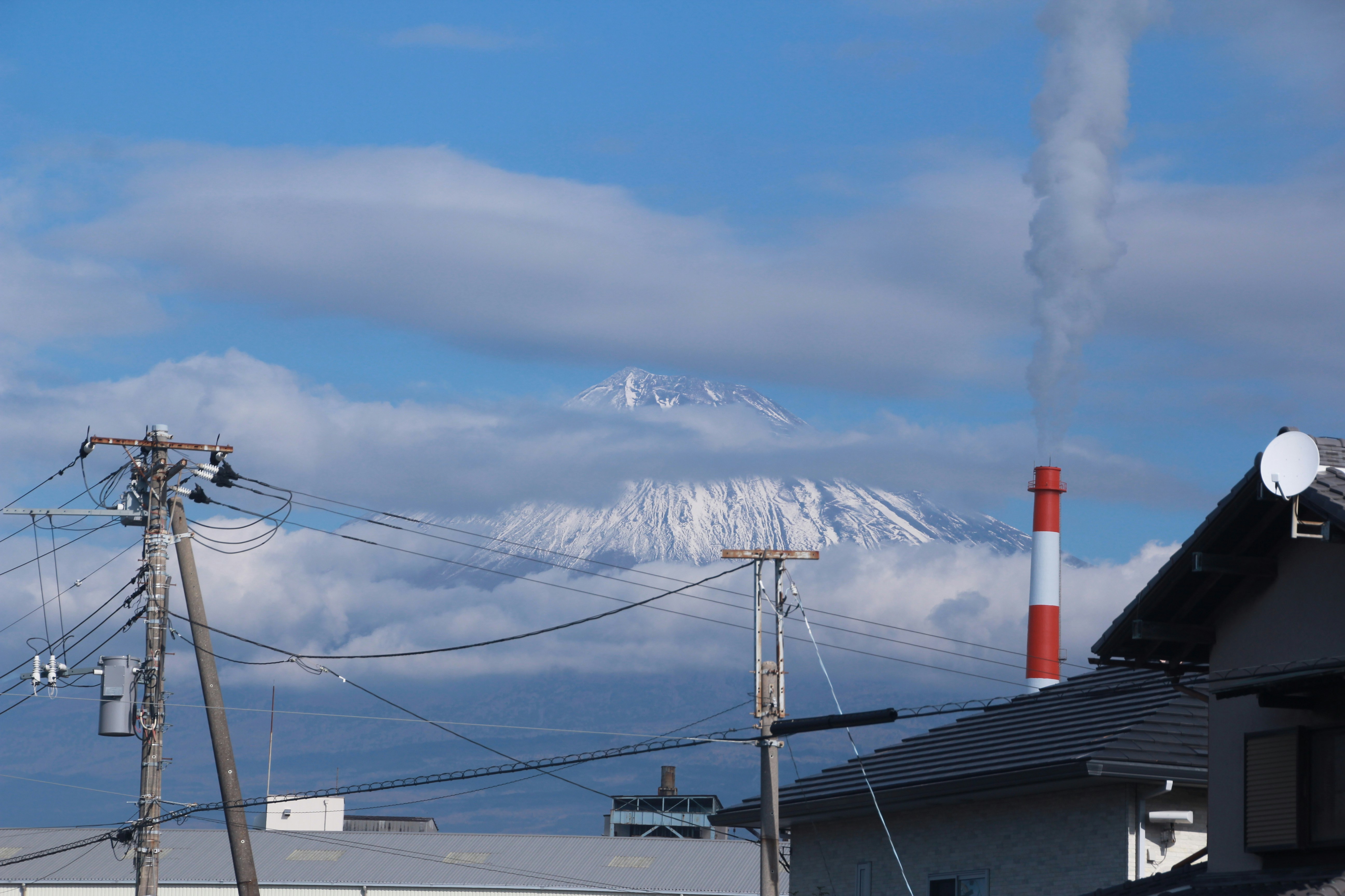 Snow-Capped Peak Rising Beyond Urban Lines