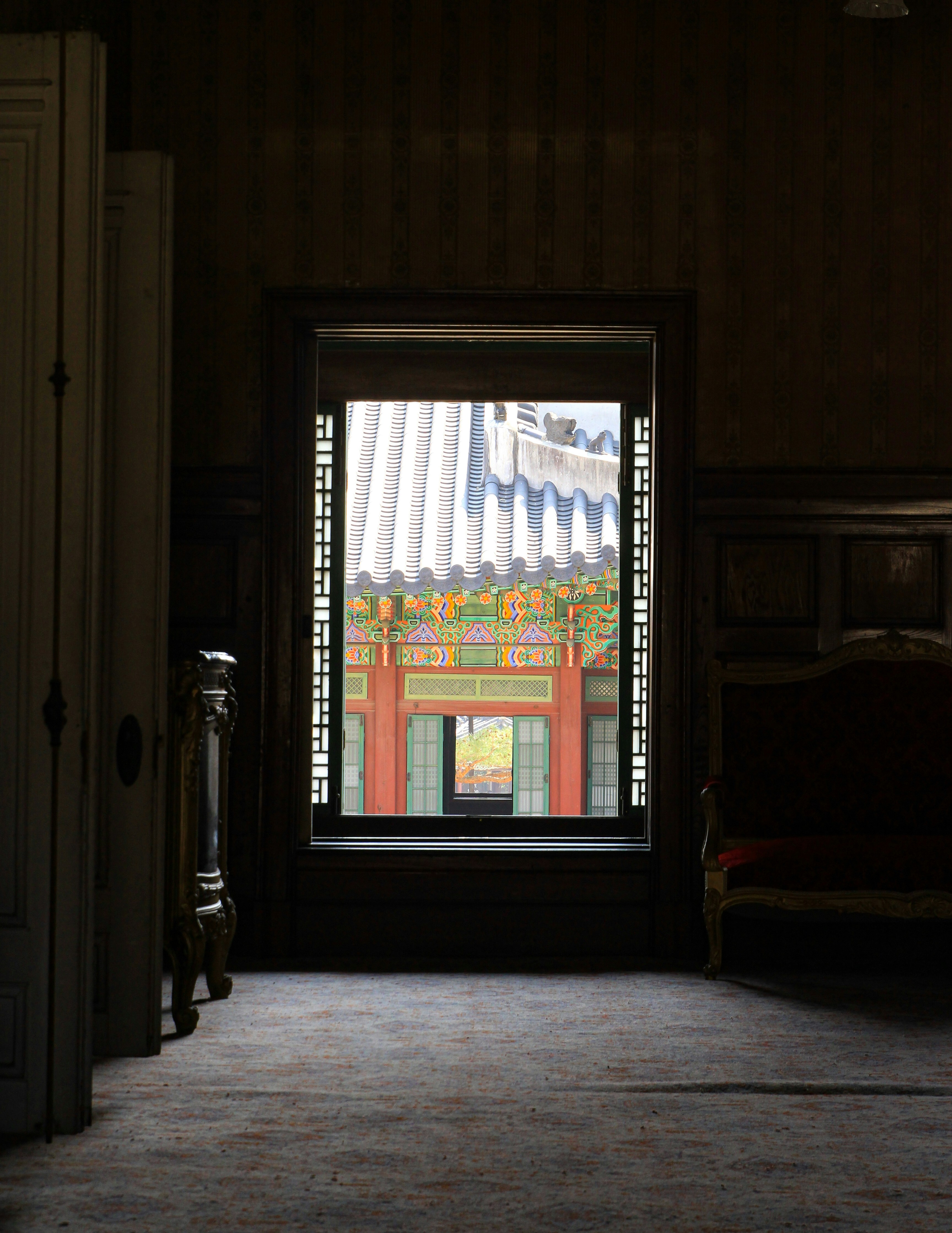 Through the Carved Frame: A Window into Colorful Korean Roofs