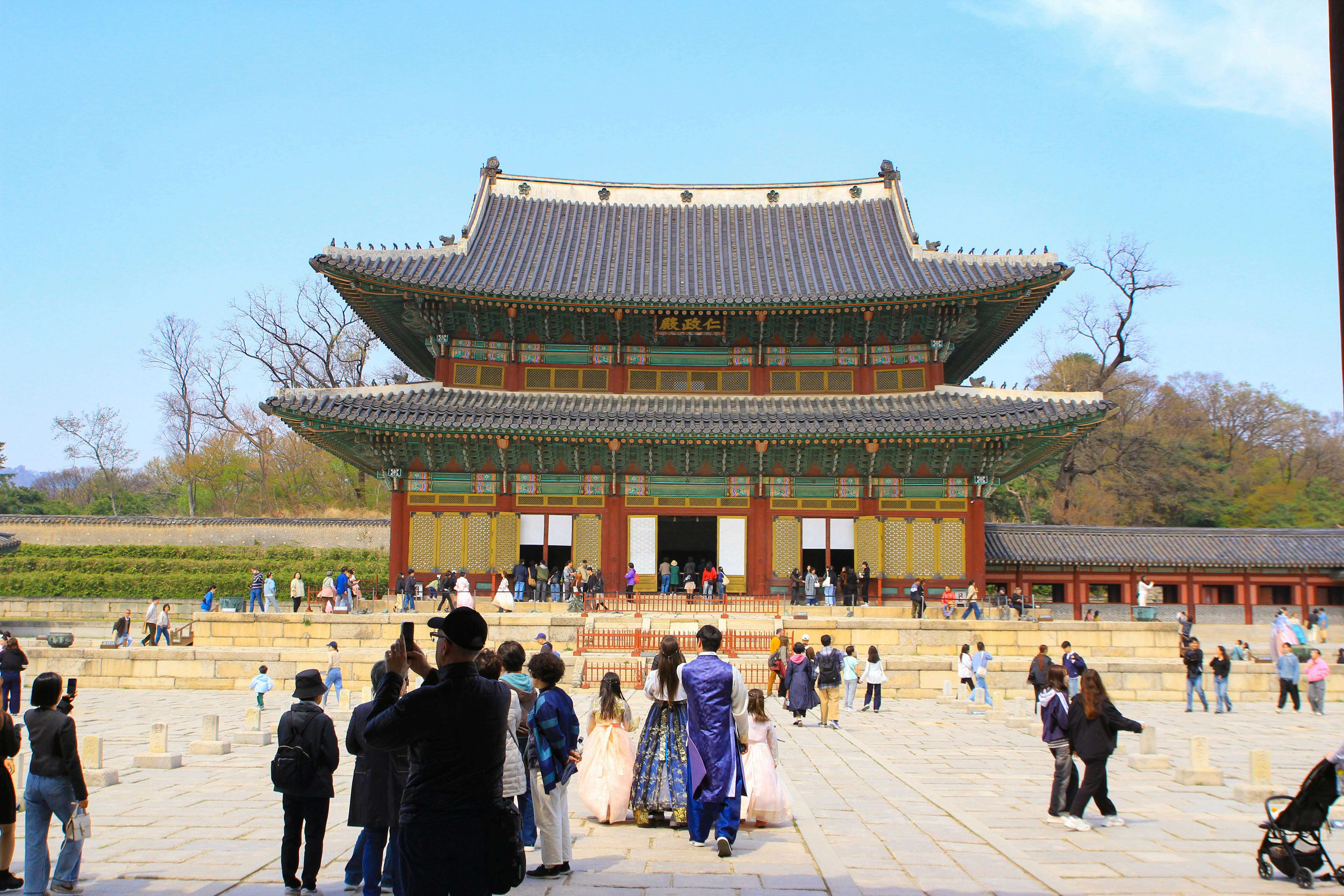 Gatehouse Grandeur: People Gather at a Traditional Korean Palace Entrance