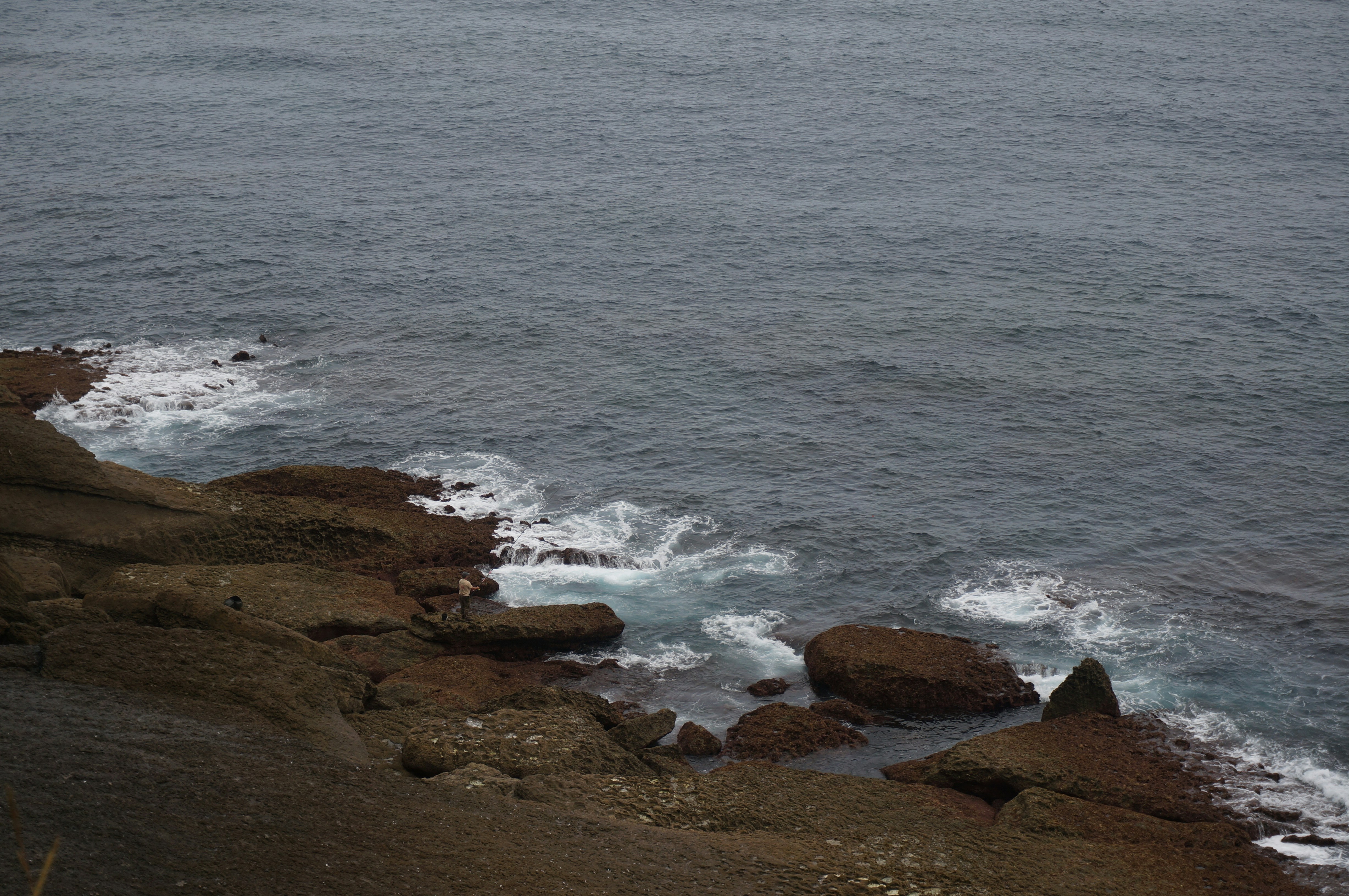 Rugged shoreline where sea meets weathered rocks