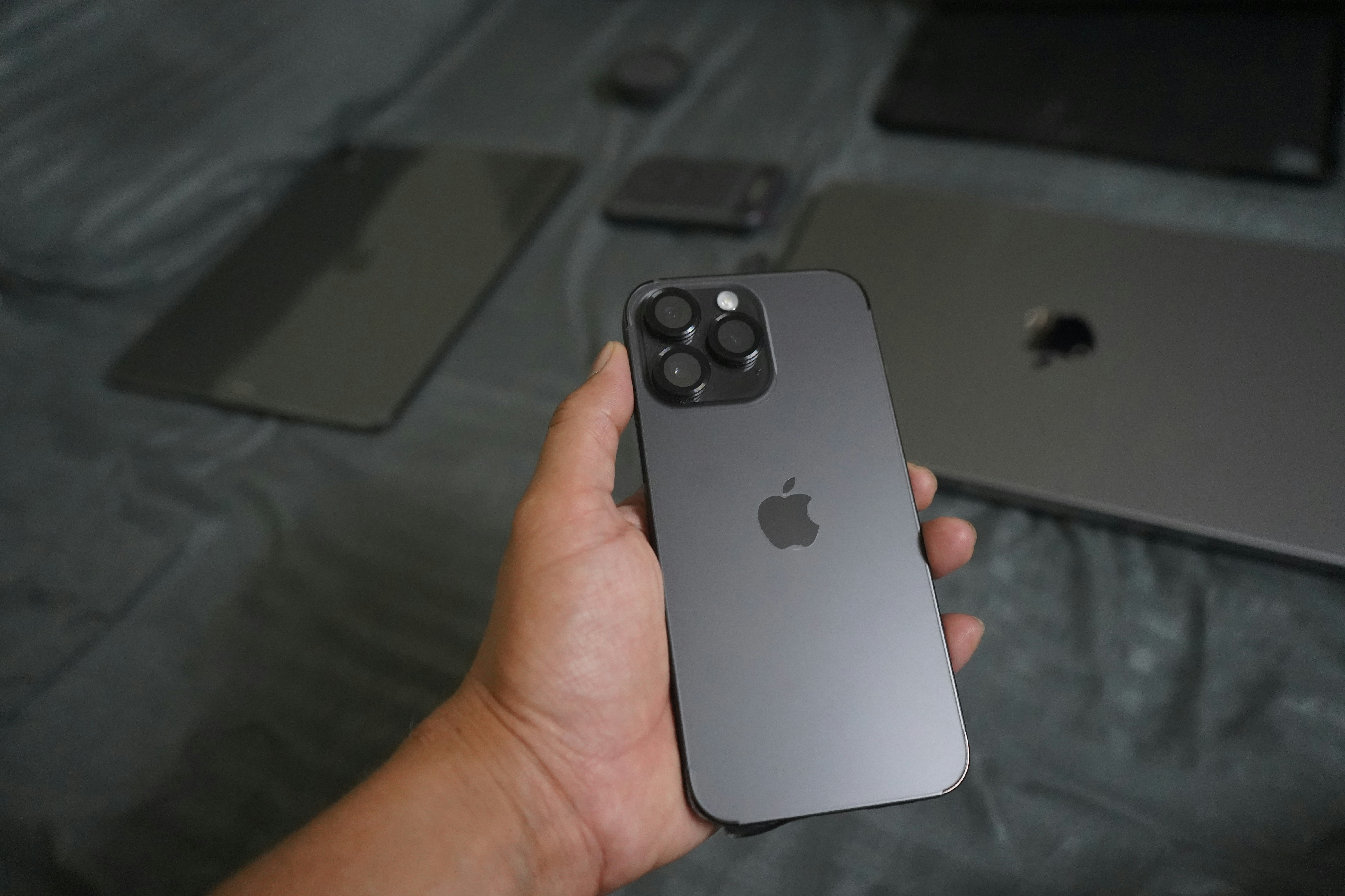 Holding Tech: A Matte Black iPhone Gripped Over a Quiet Desk