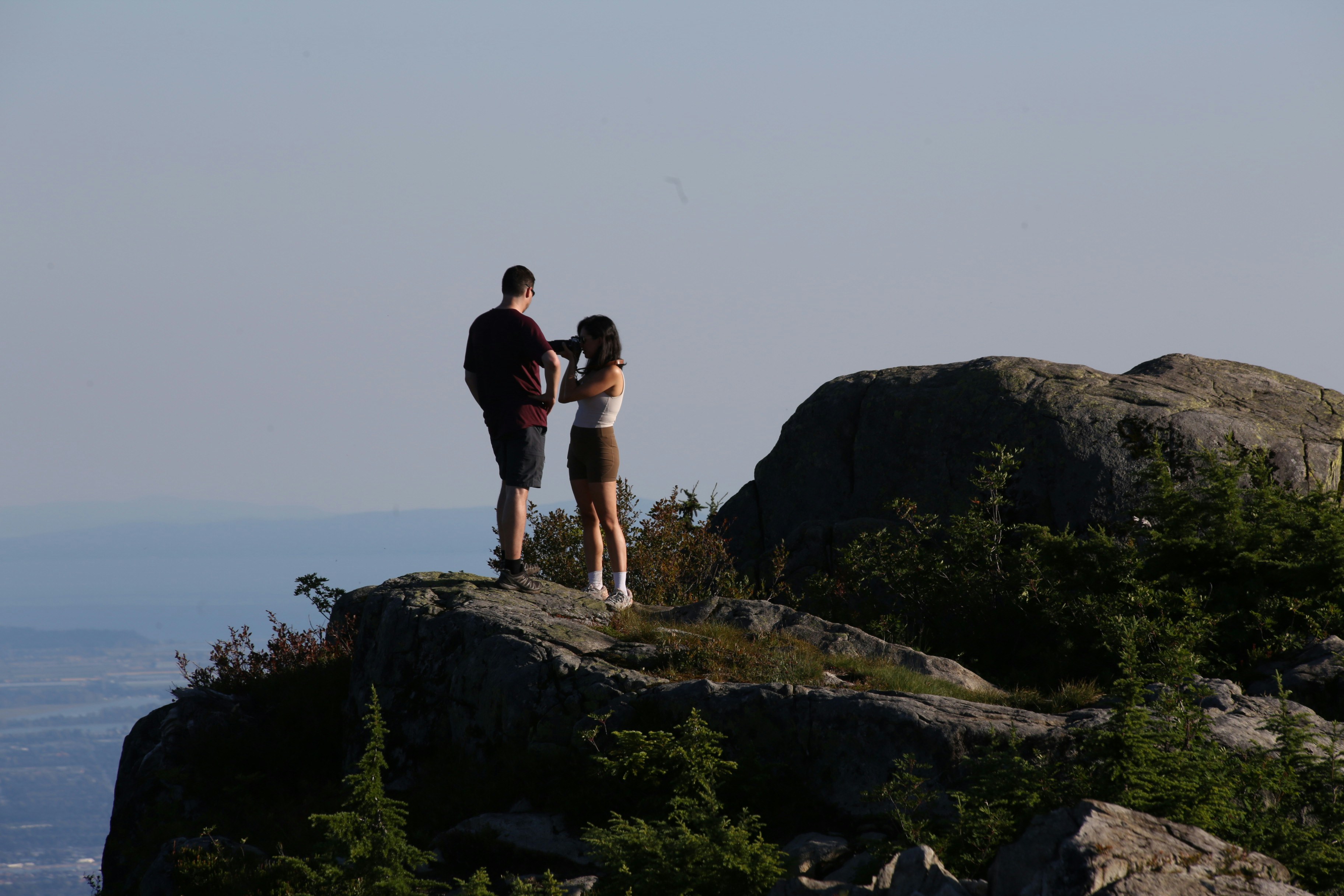 Two Figures on a Cliff Edge: Quiet Conversation Above the World