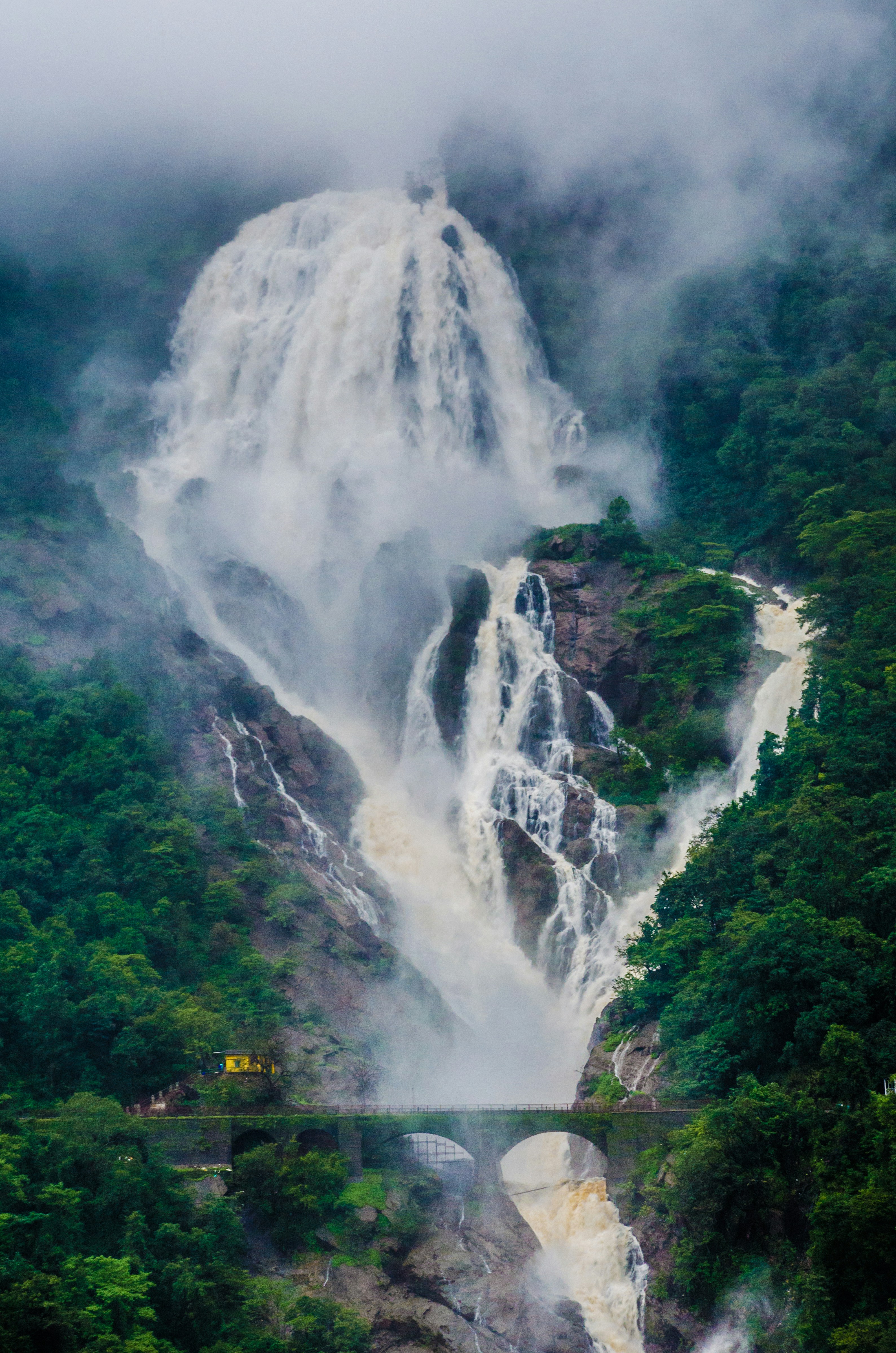 Monsoon Cascade: A Vertical Symphony Over Stone and Mist