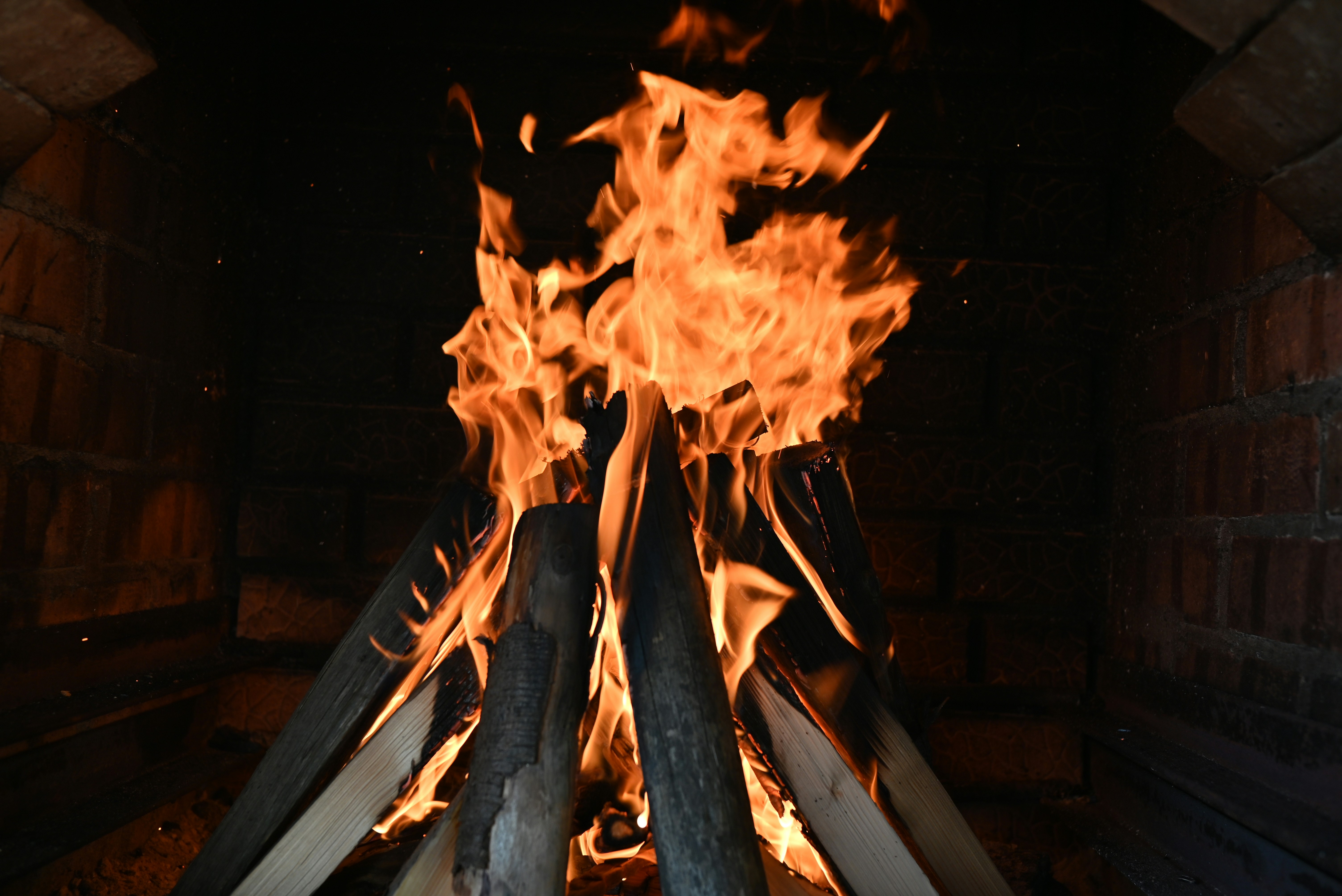 Crackling Hearth: Neon Flame Within a Brick Enclosure