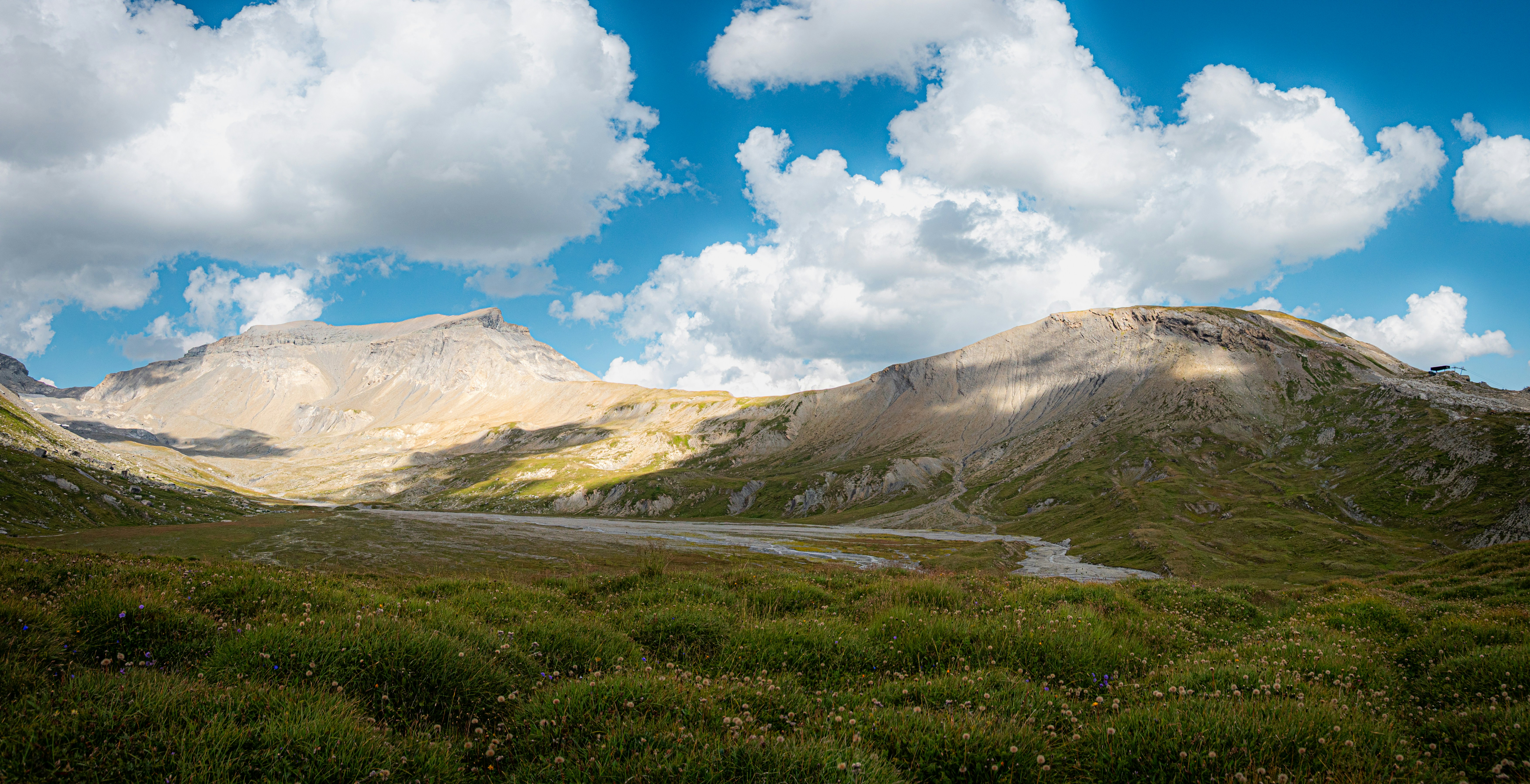 Dusty Alpine Trails Beneath a Vault of Clouds