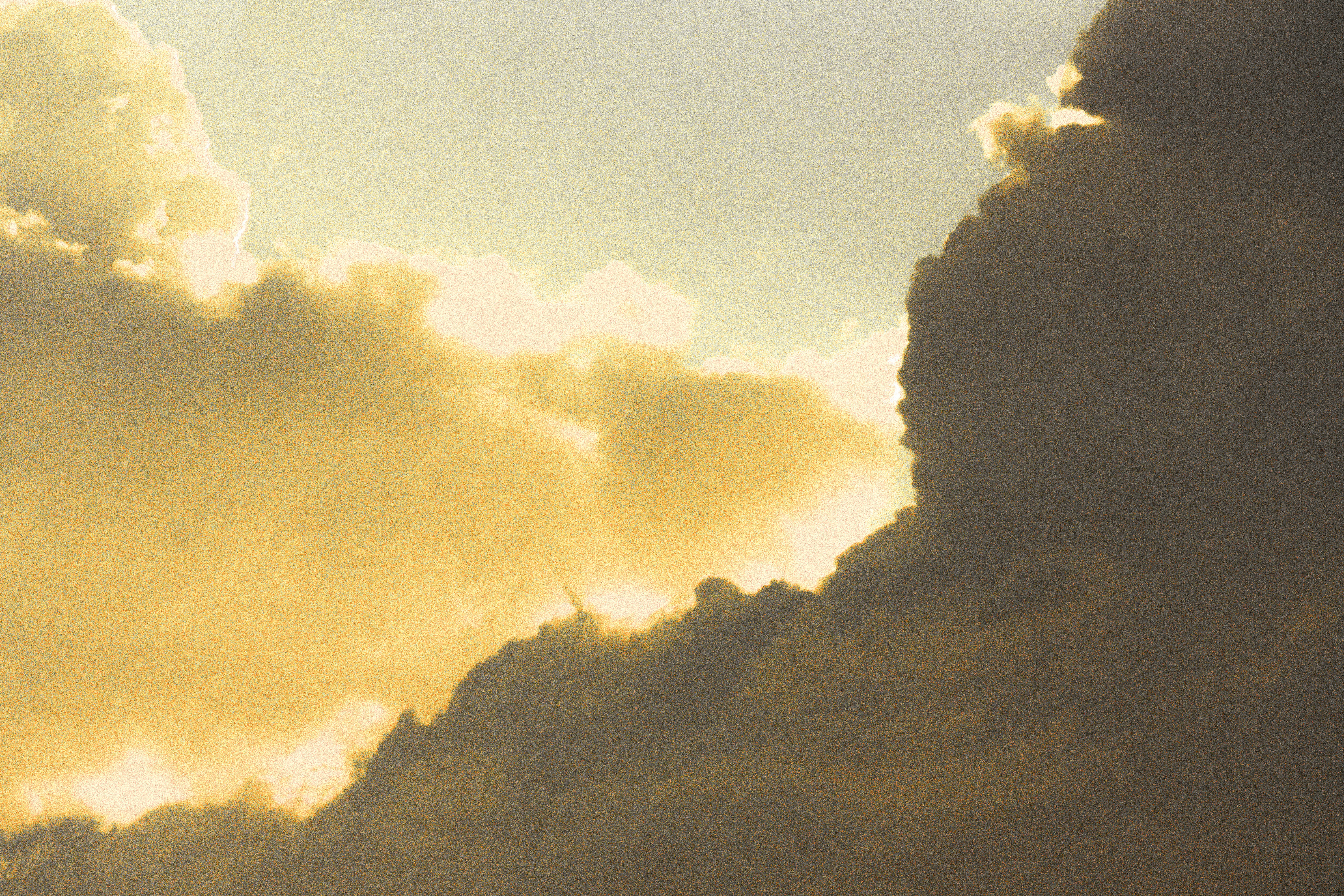 Sunlit Crest: Clouds Framing a Quiet Dawn