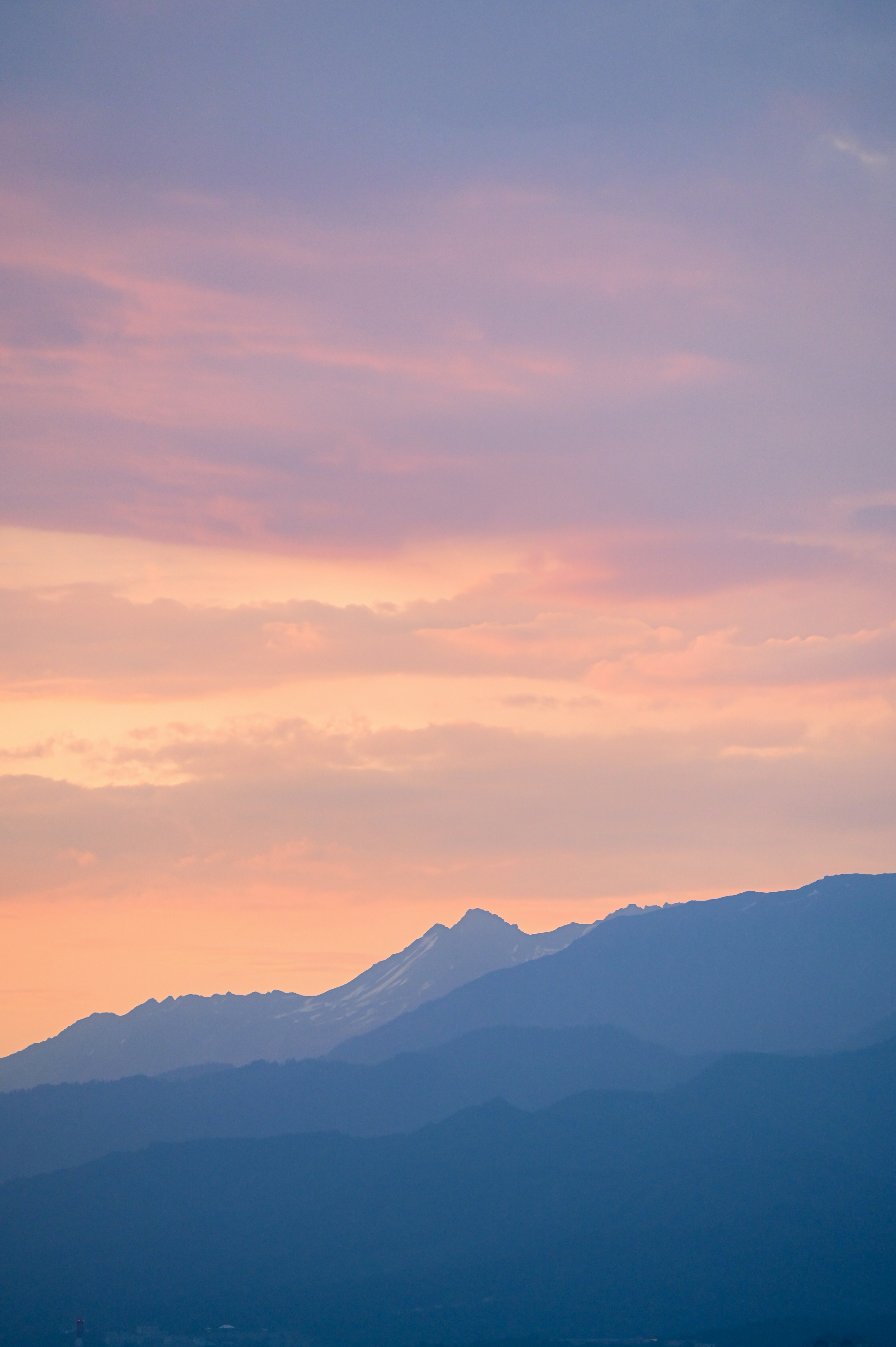 Soft Horizon: A Mountain Silhouette Beneath Spring-Pastel Skies