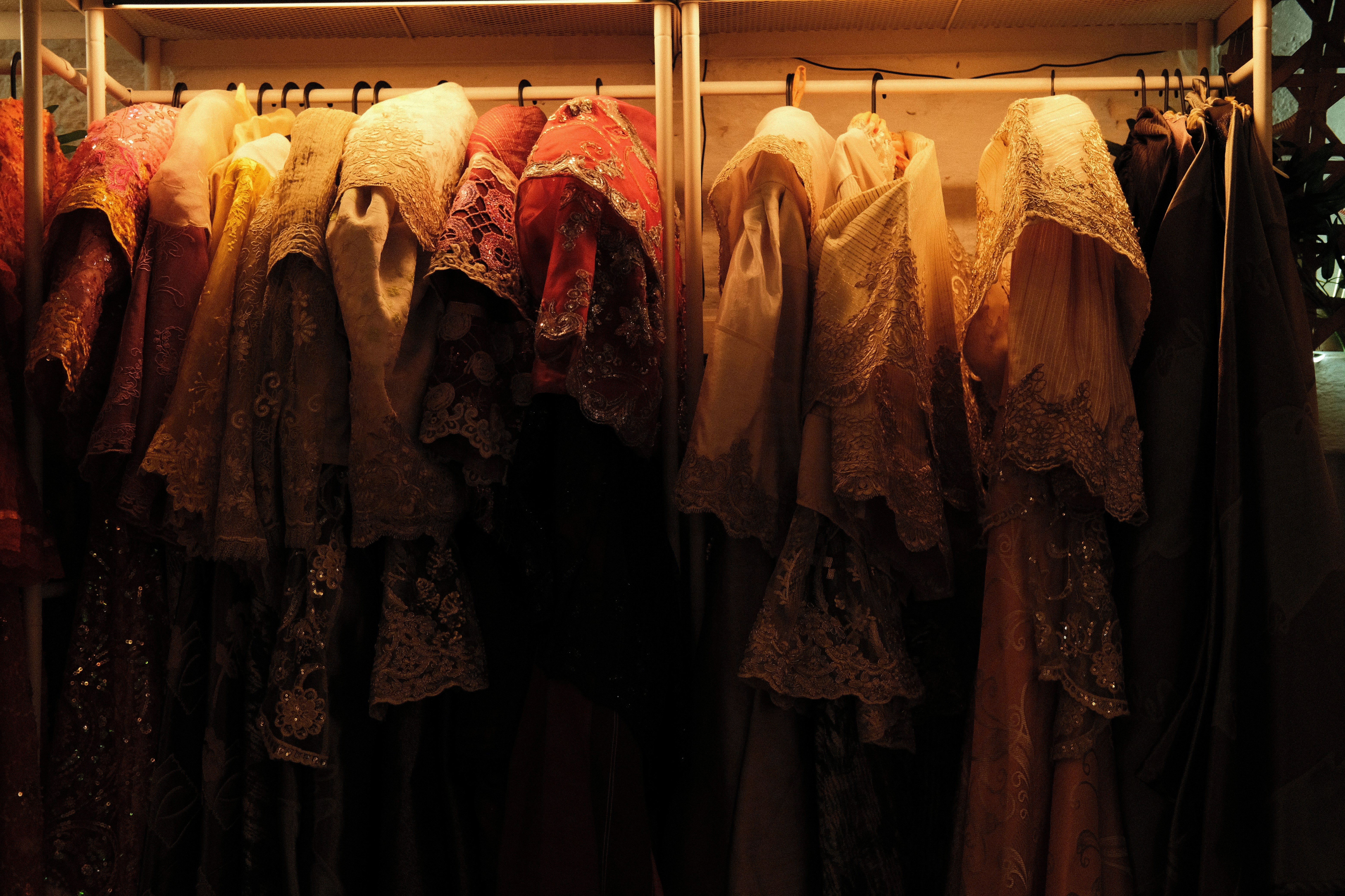 Velvet Hues: Evening Garment Rack in Soft Dim Light