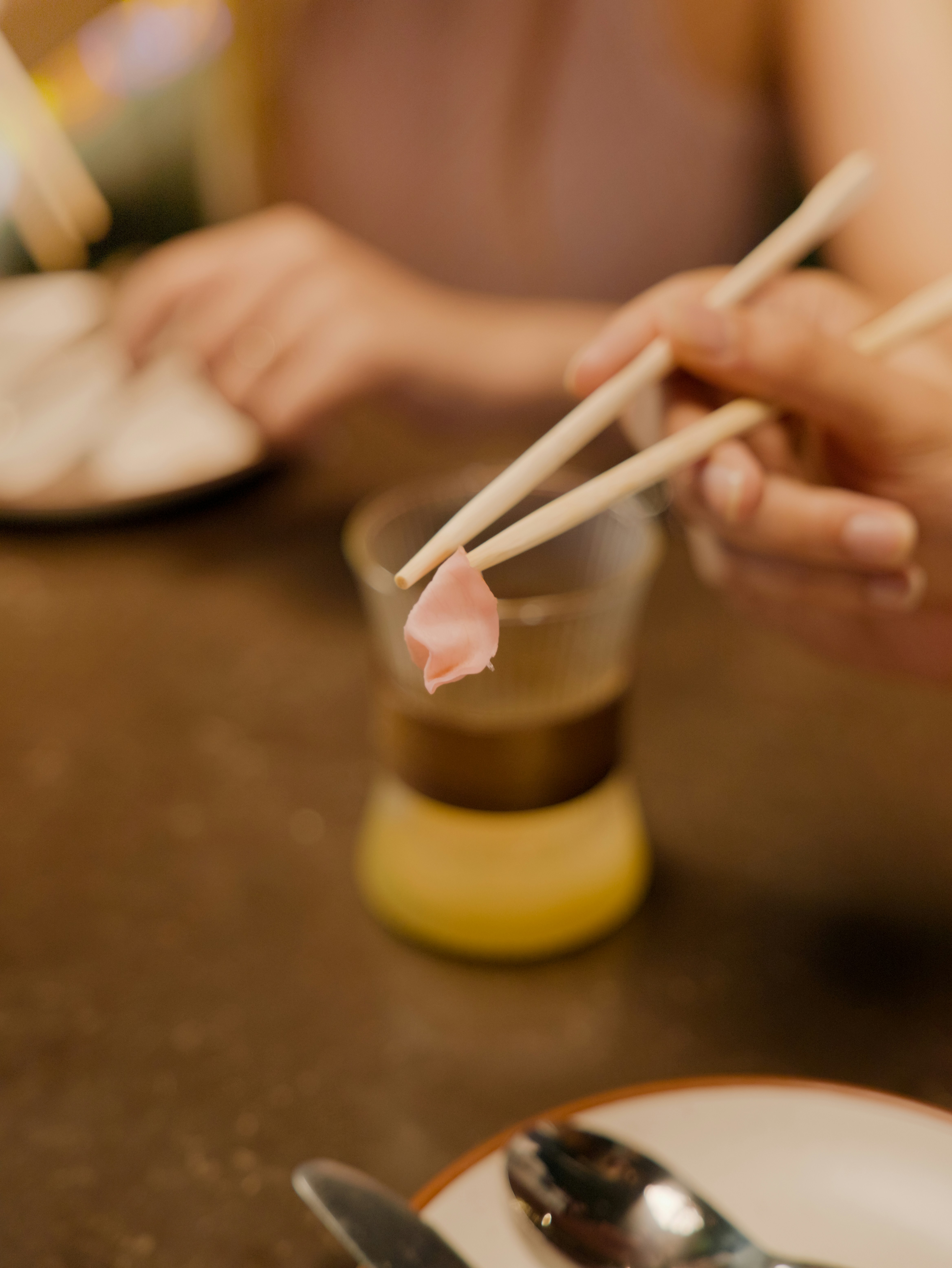 Chopsticks Pause: A Moment with Delicate Dumpling in Soft Restaurant Light