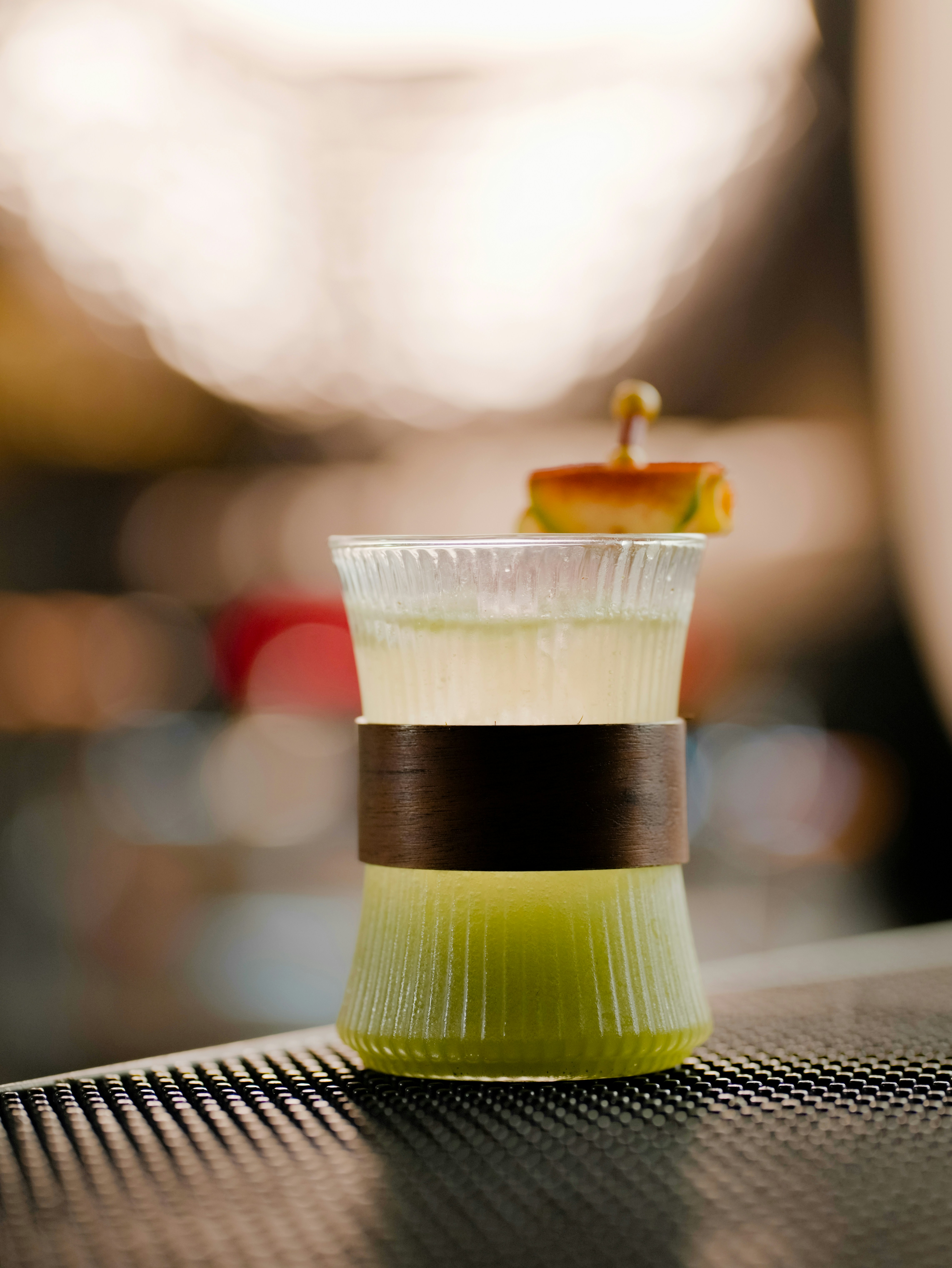 Citrus Glow: A Tapered Glass Cocktail Centered in Soft Focus