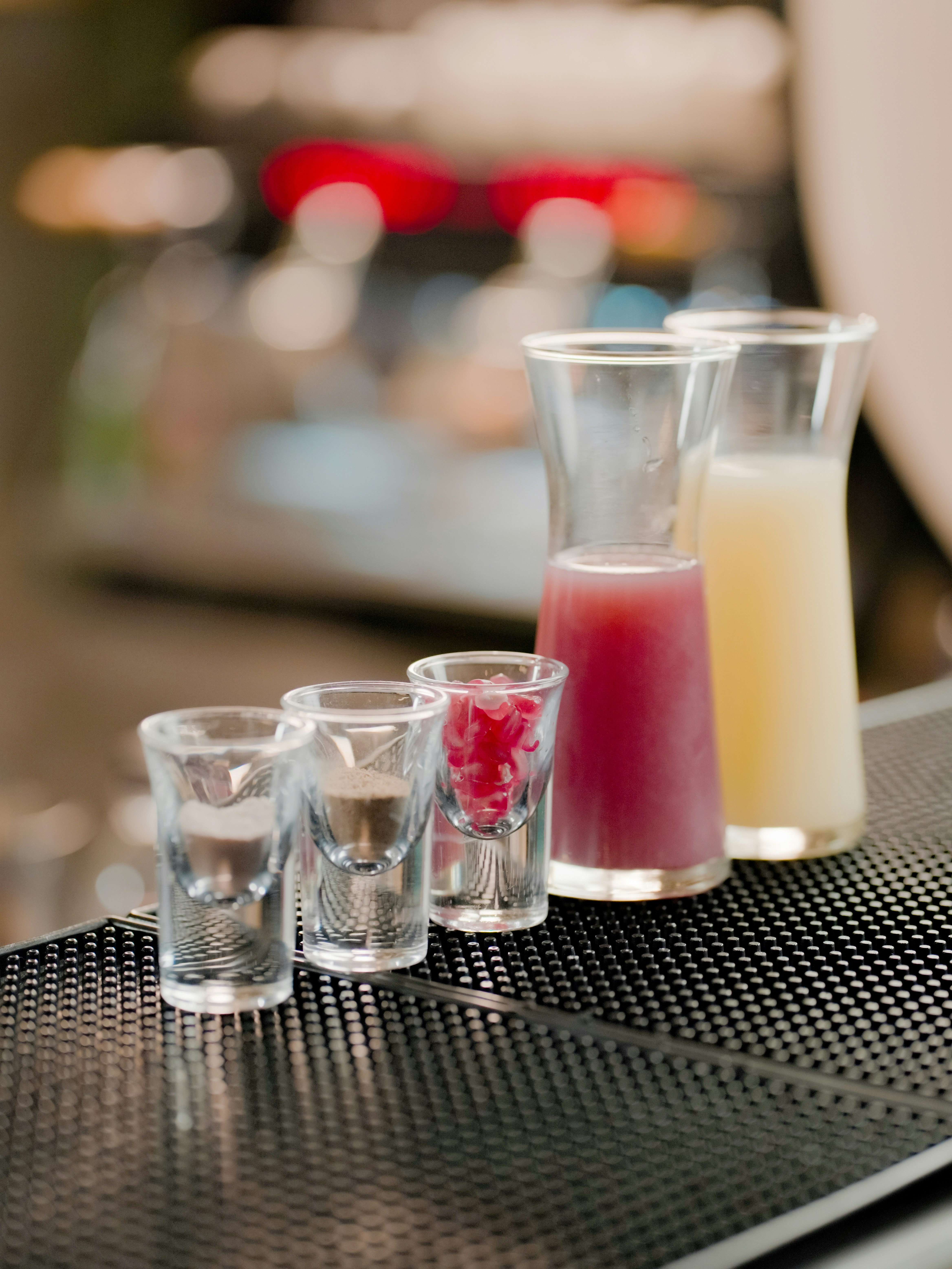 Bottles and shot glasses on a textured bar counter
