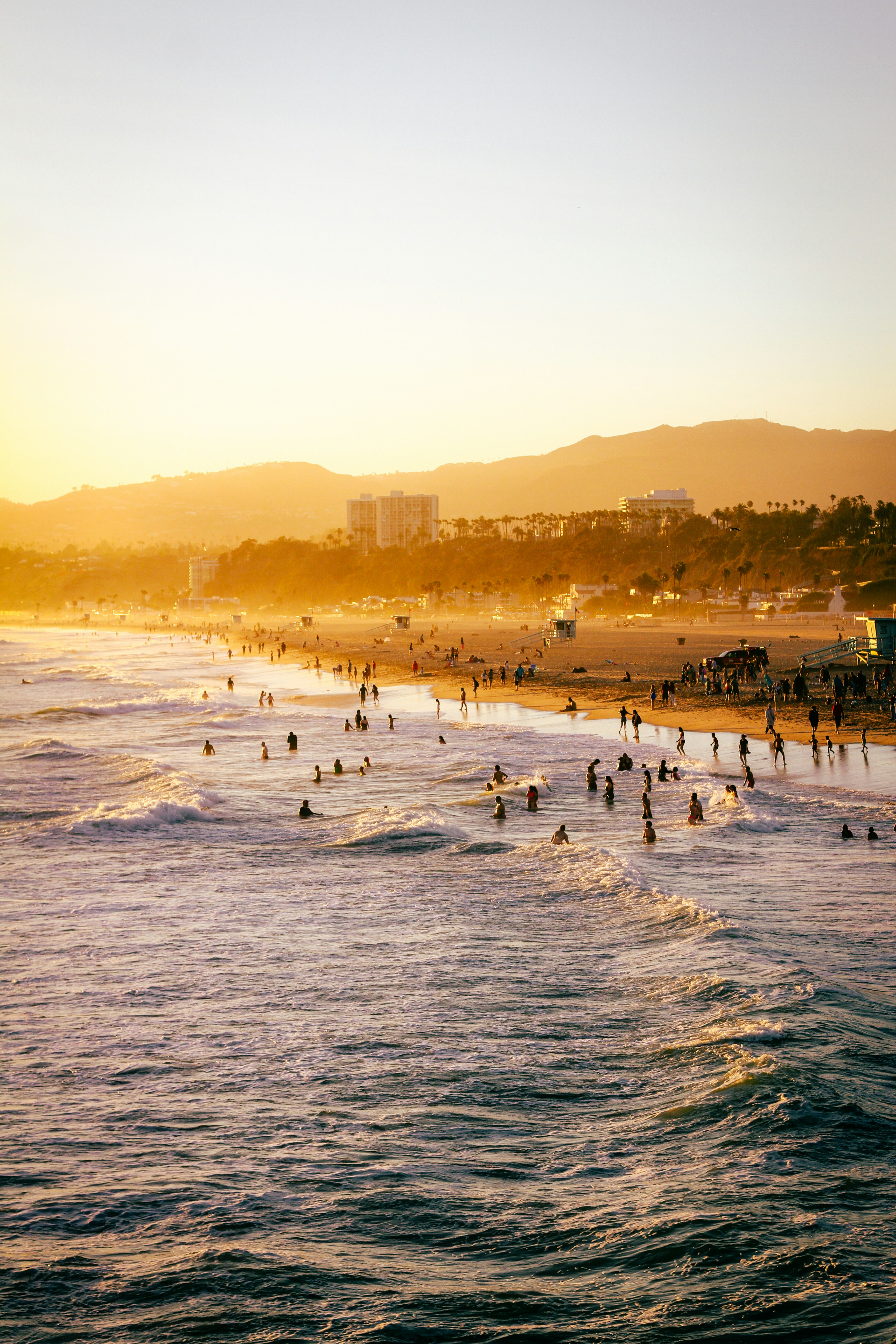 Golden Sands at Dusk: A Coastal Crowd Beneath Ocean Hues