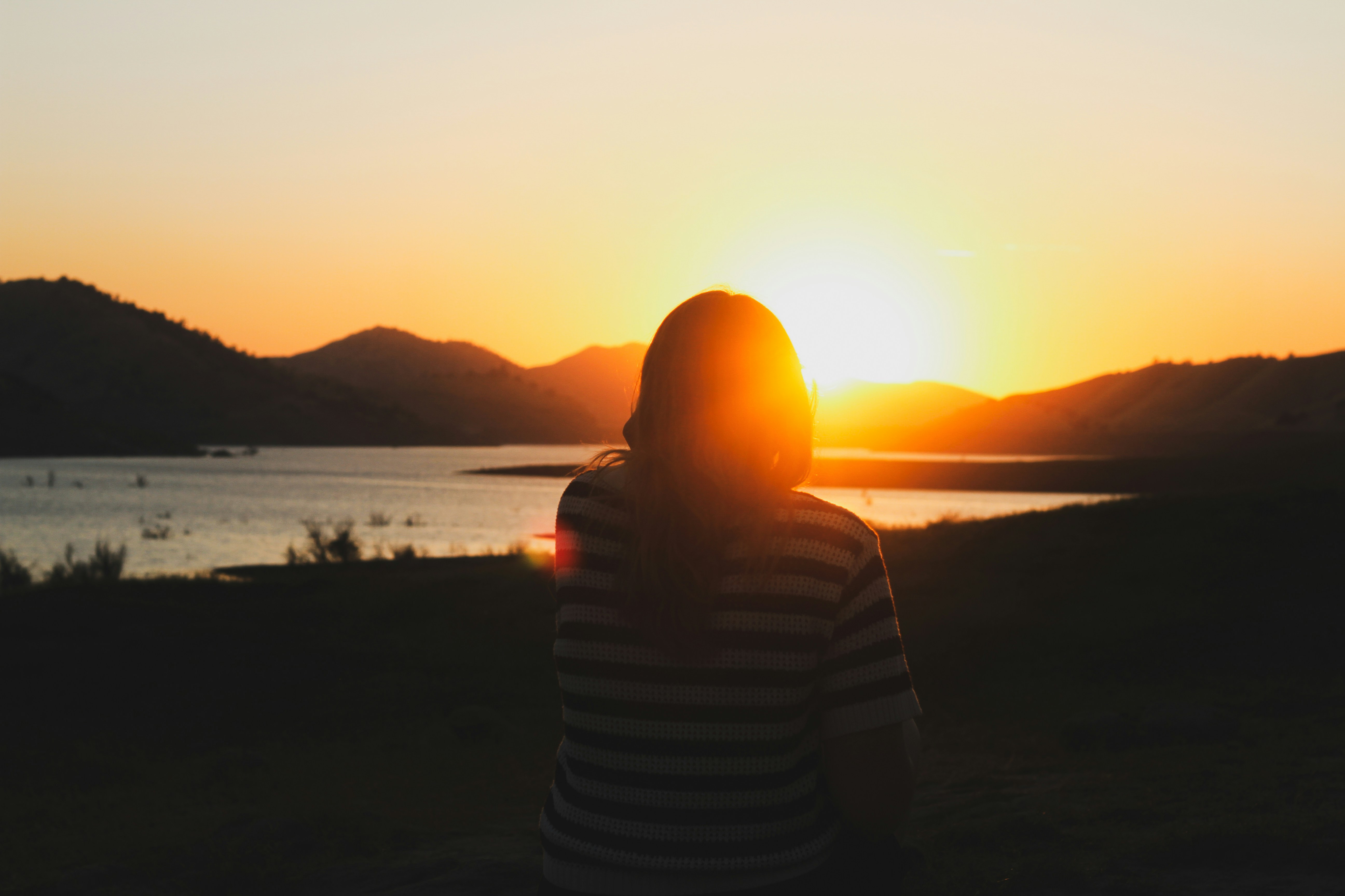 Sun-Kissed Silhouette by a Quiet Lake