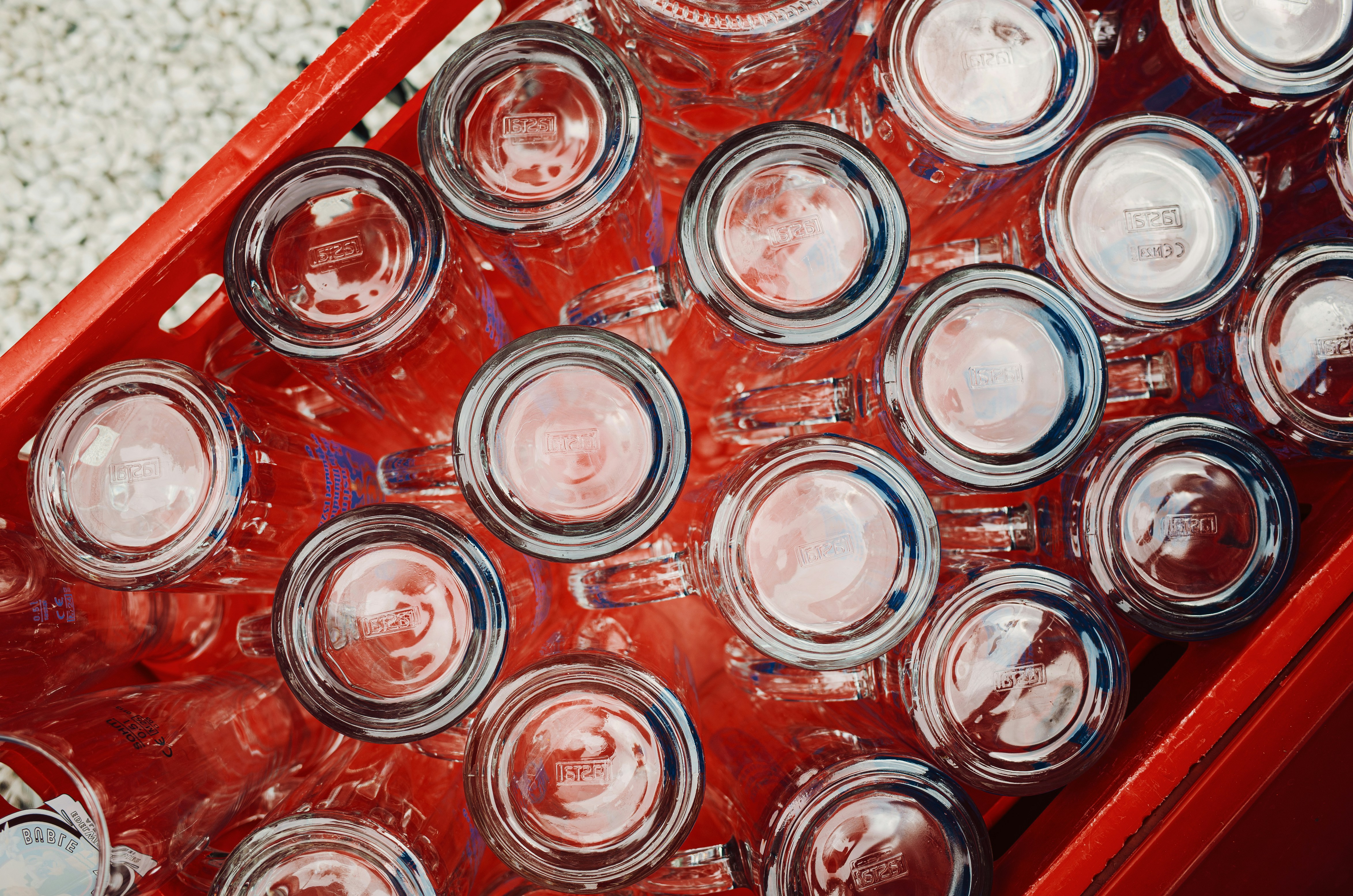 Red Ringed Deluge: A Grid of Glass Jars in a Crate